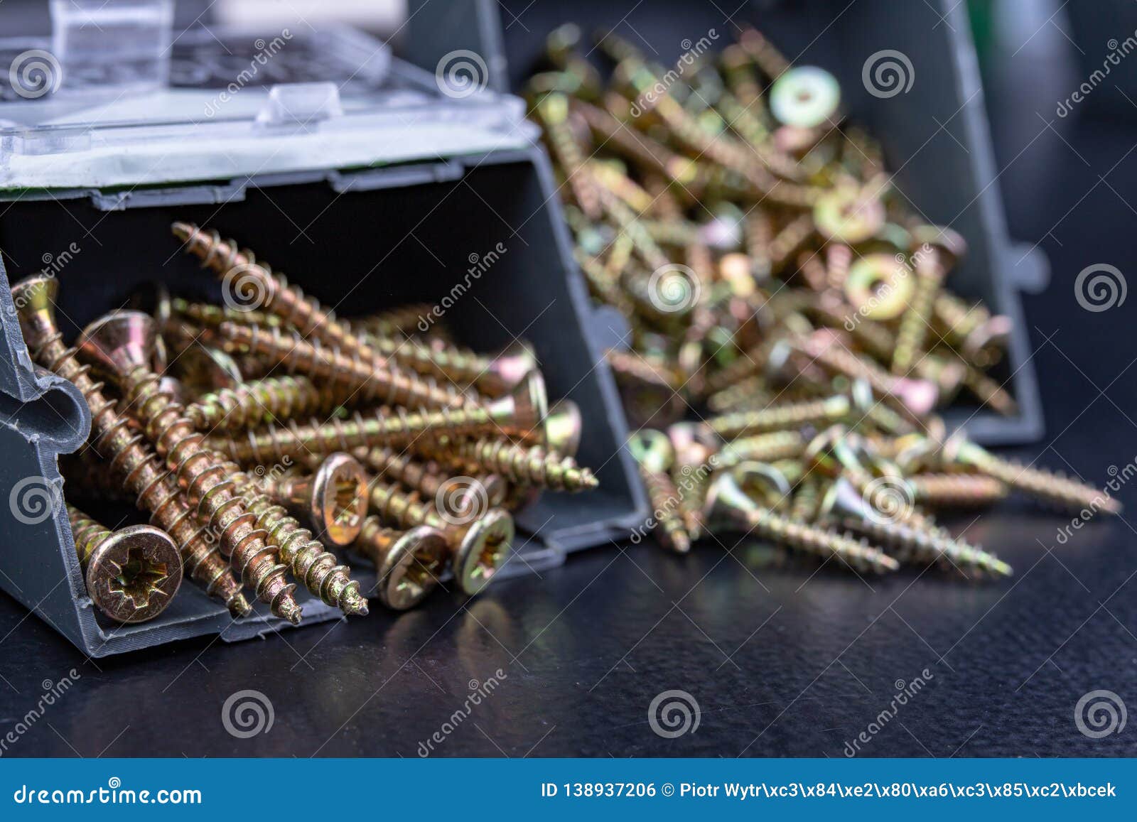 Screws in a Box and a Screwdriver on a Workshop Table. Accessories for ...