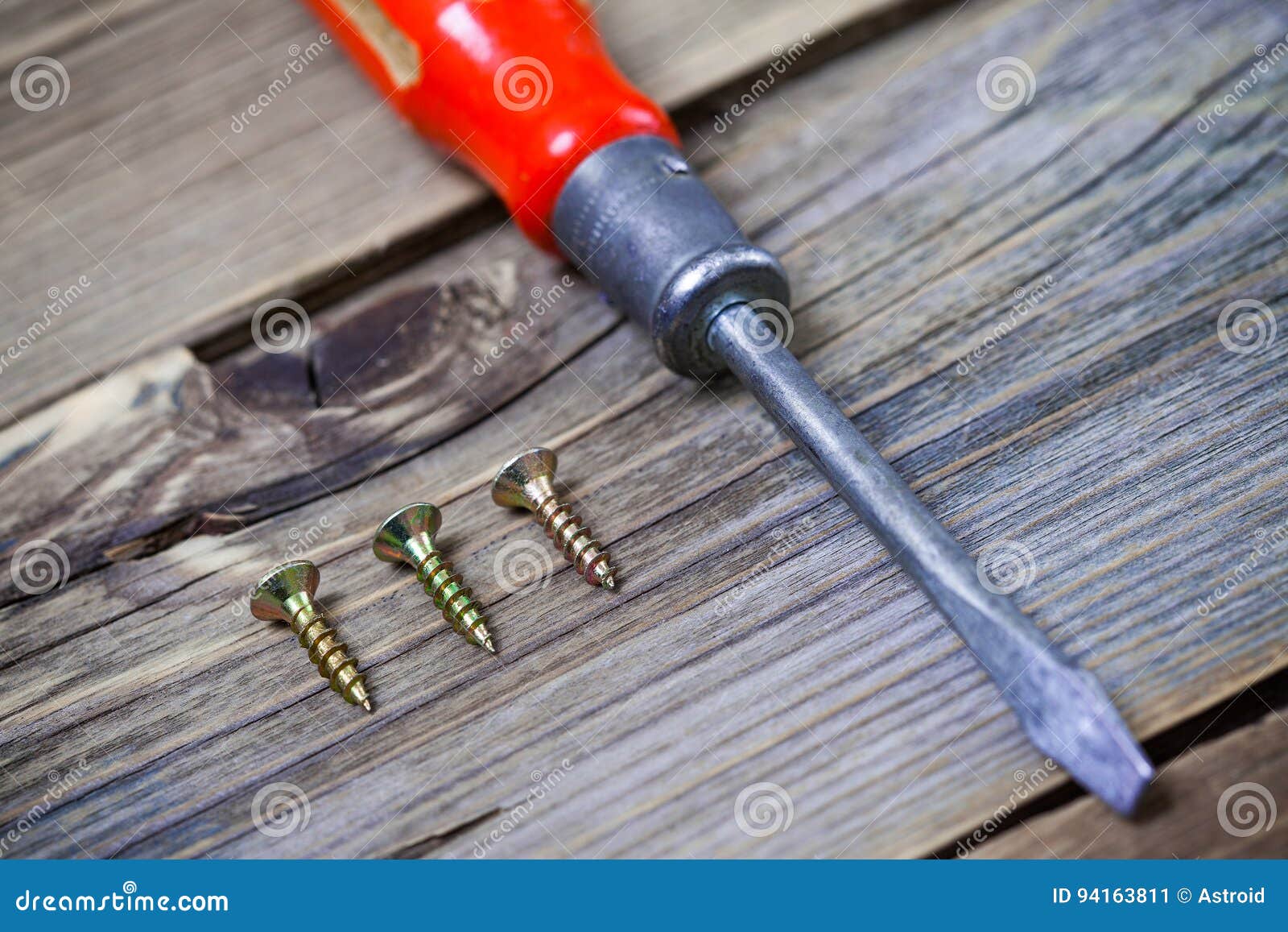 Screws and Old Screwdriver with a Red Wooden Handle Stock Image - Image ...
