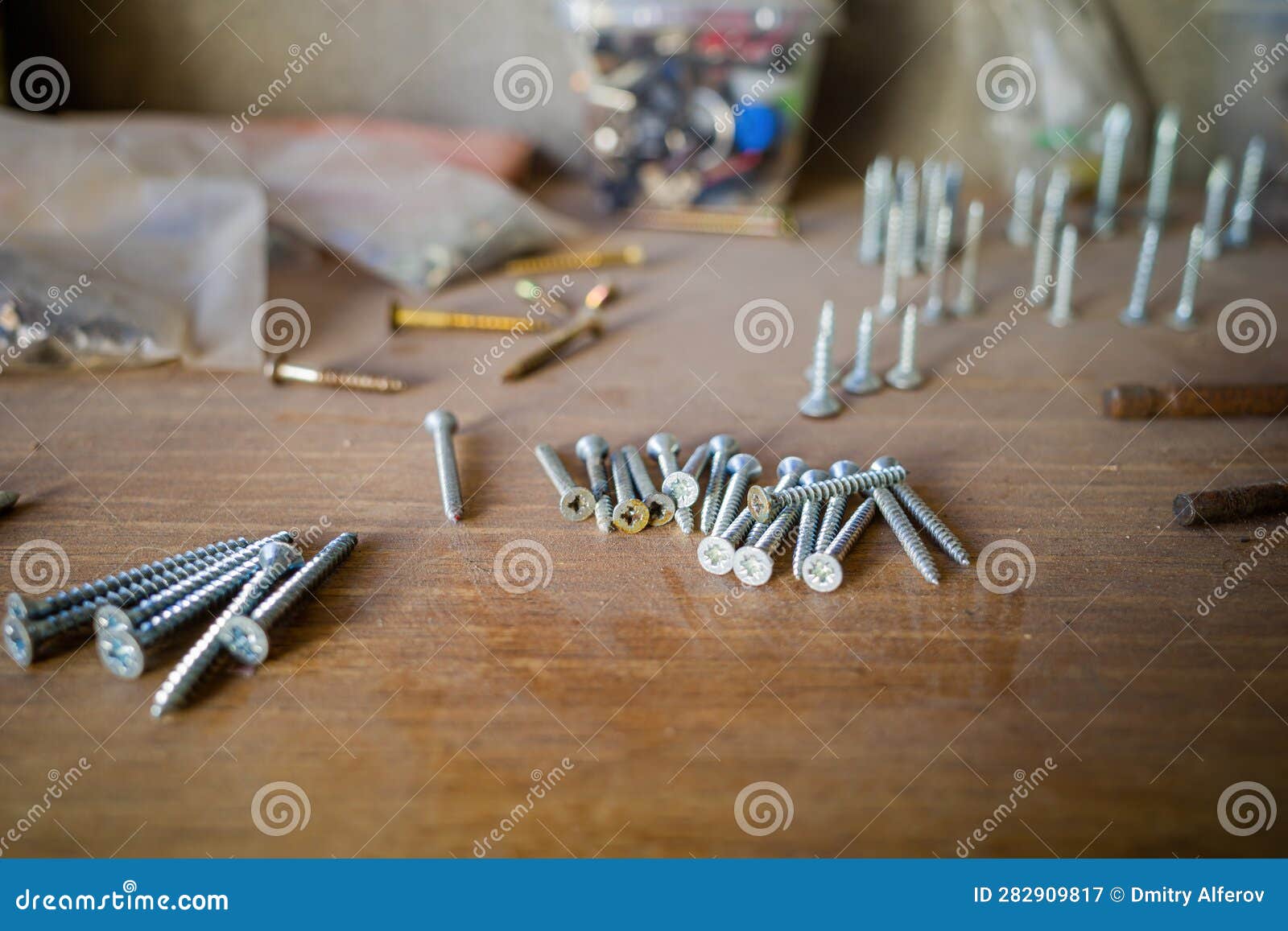 Screws and Self-tapping Screws of Various Lengths on a Wooden Table ...