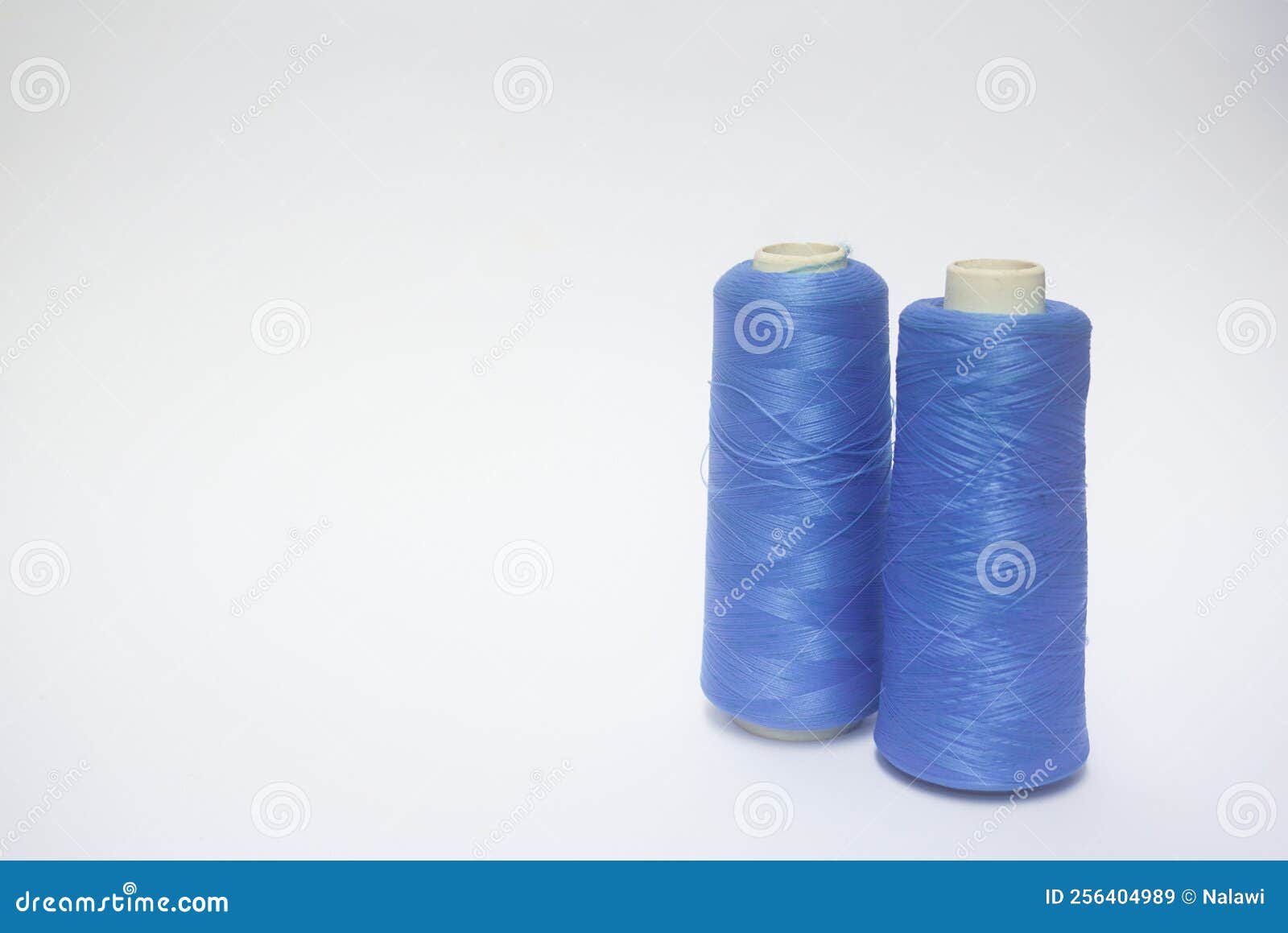 A Scroll Blue Color Sewing Thread with White Background for Sewing ...