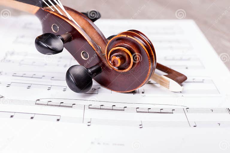 Scroll of the Classical Violin on Music Notes Stock Image - Image of ...