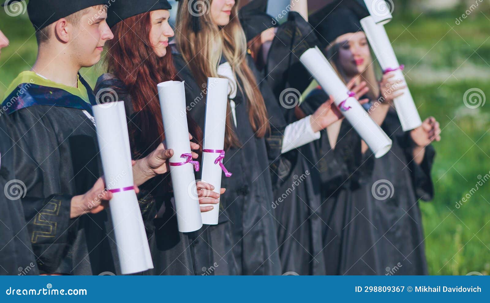 Scrolls Of Diplomas In The Hands Of A Group Of Graduates. Stock Image ...