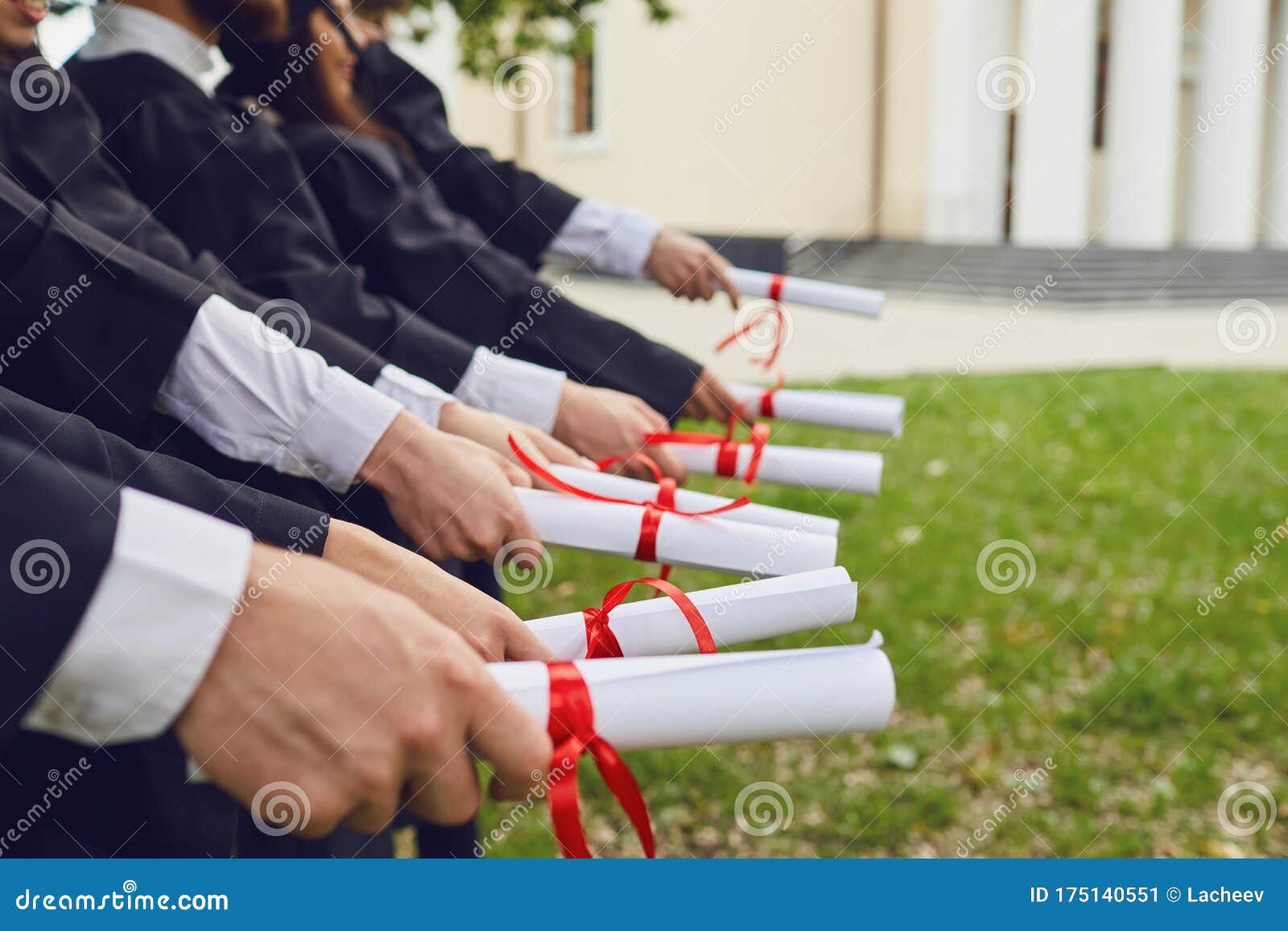 Scrolls of Diplomas in the Hands of a Group of Graduates. Stock Image ...