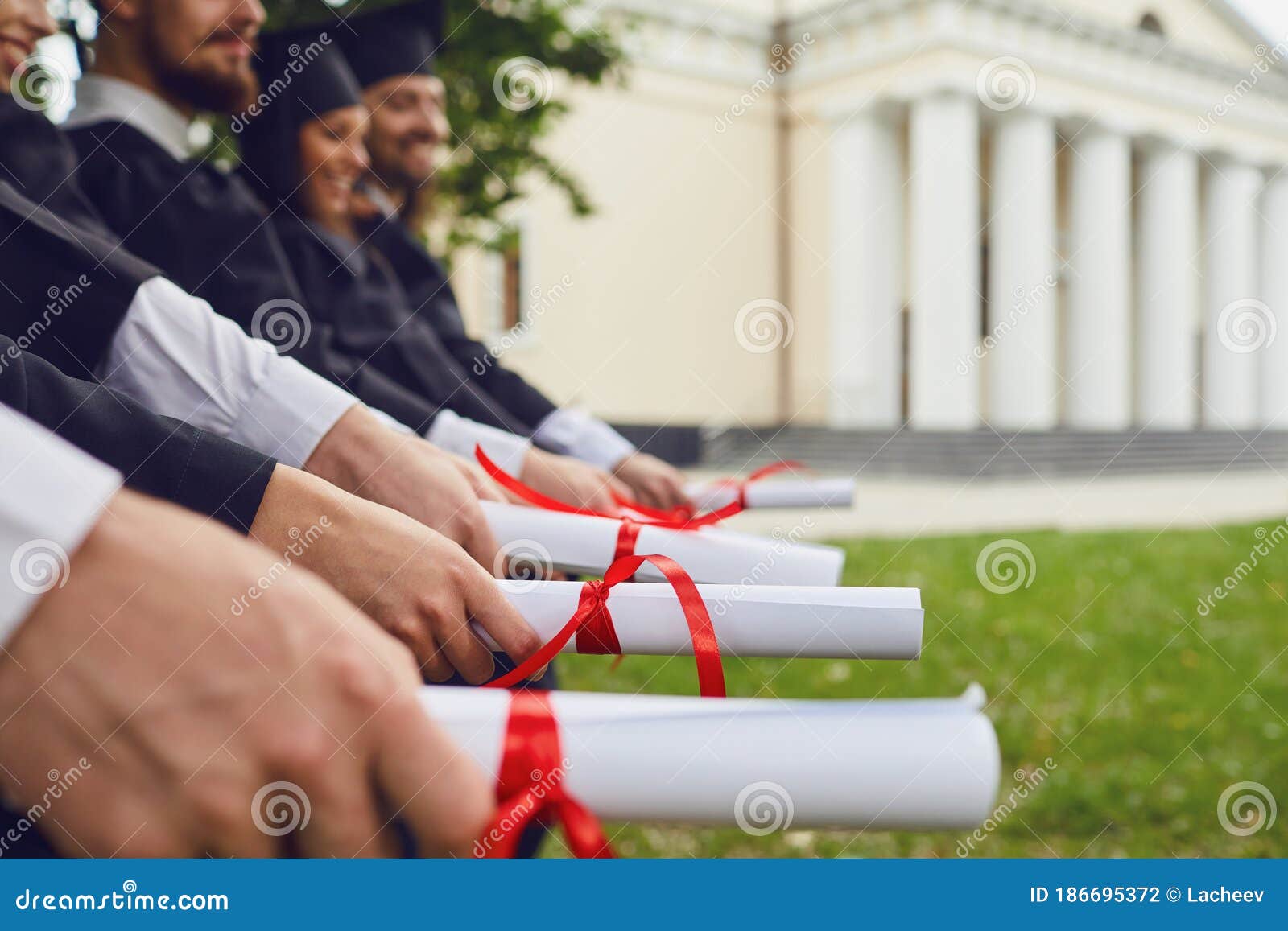 Scrolls of Diplomas in the Hands of a Group of Graduates. Stock Photo ...