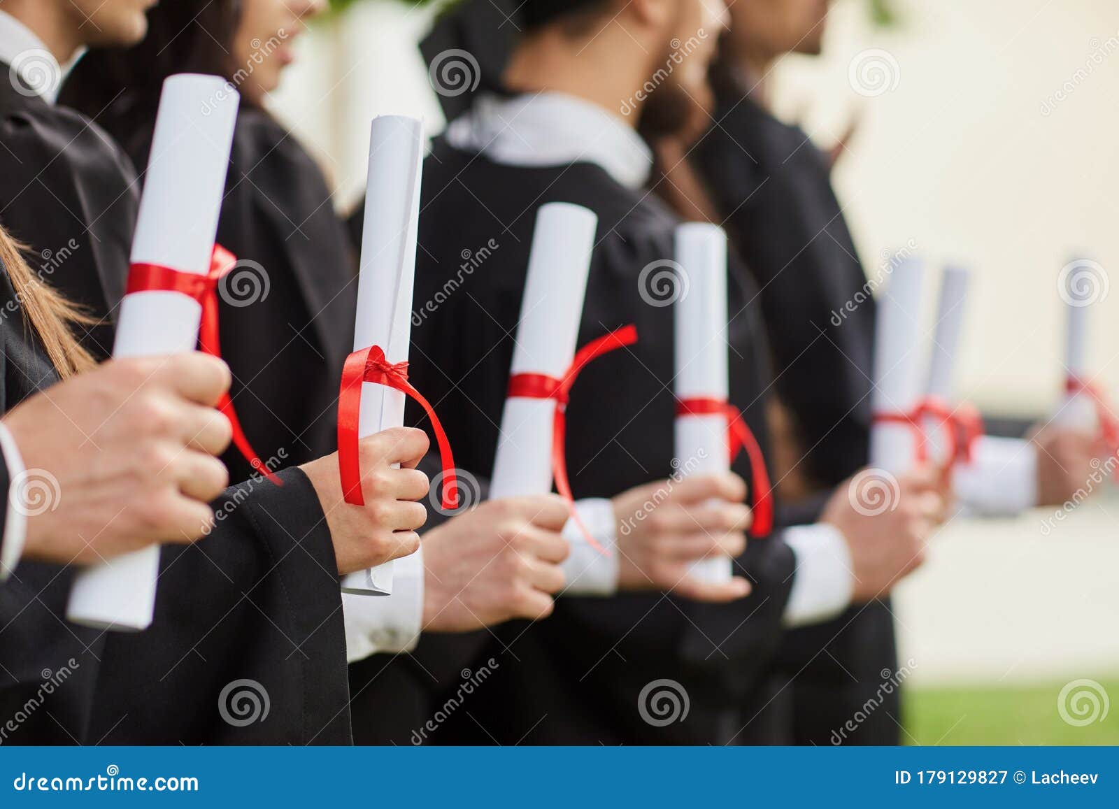 Scrolls of Diplomas in the Hands of a Group of Graduates. Stock Image ...