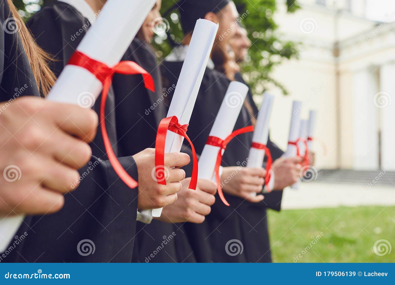 Scrolls of Diplomas in the Hands of a Group of Graduates. Stock Image ...
