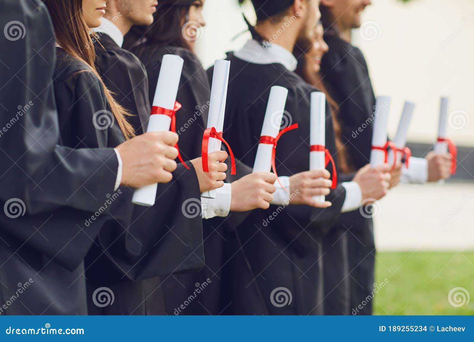 Scrolls of Diplomas in the Hands of a Group of Graduates. Stock Photo ...