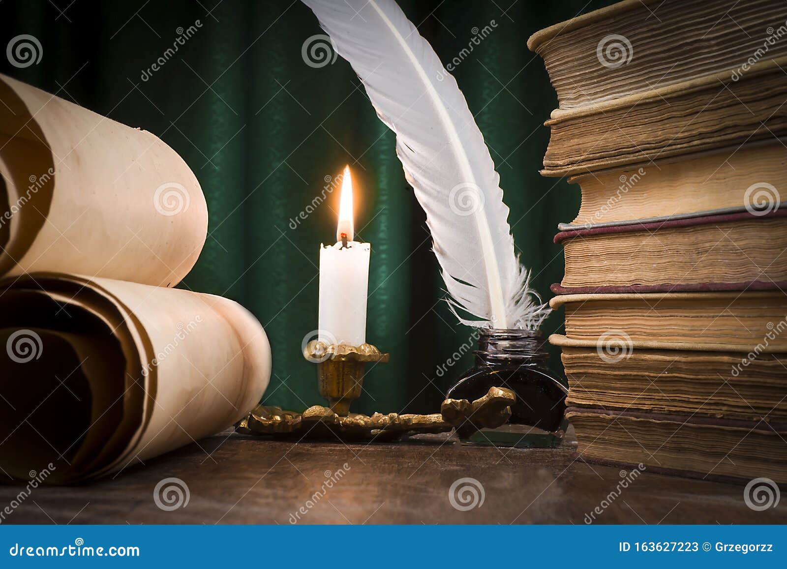 Scrolls of Parchment, a Stack of Books, and a Lit Candle Stock Image ...