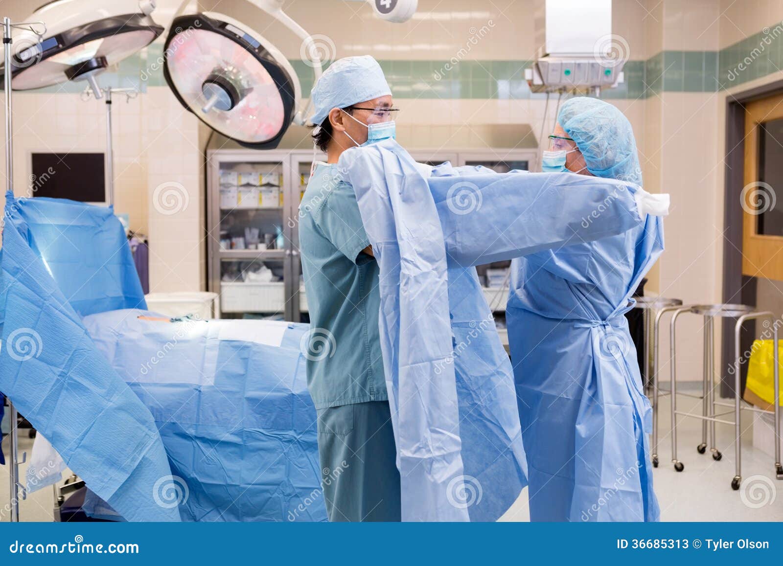 Scrub Nurse Putting Sterile Gown On Surgeon Stock Image Image Of