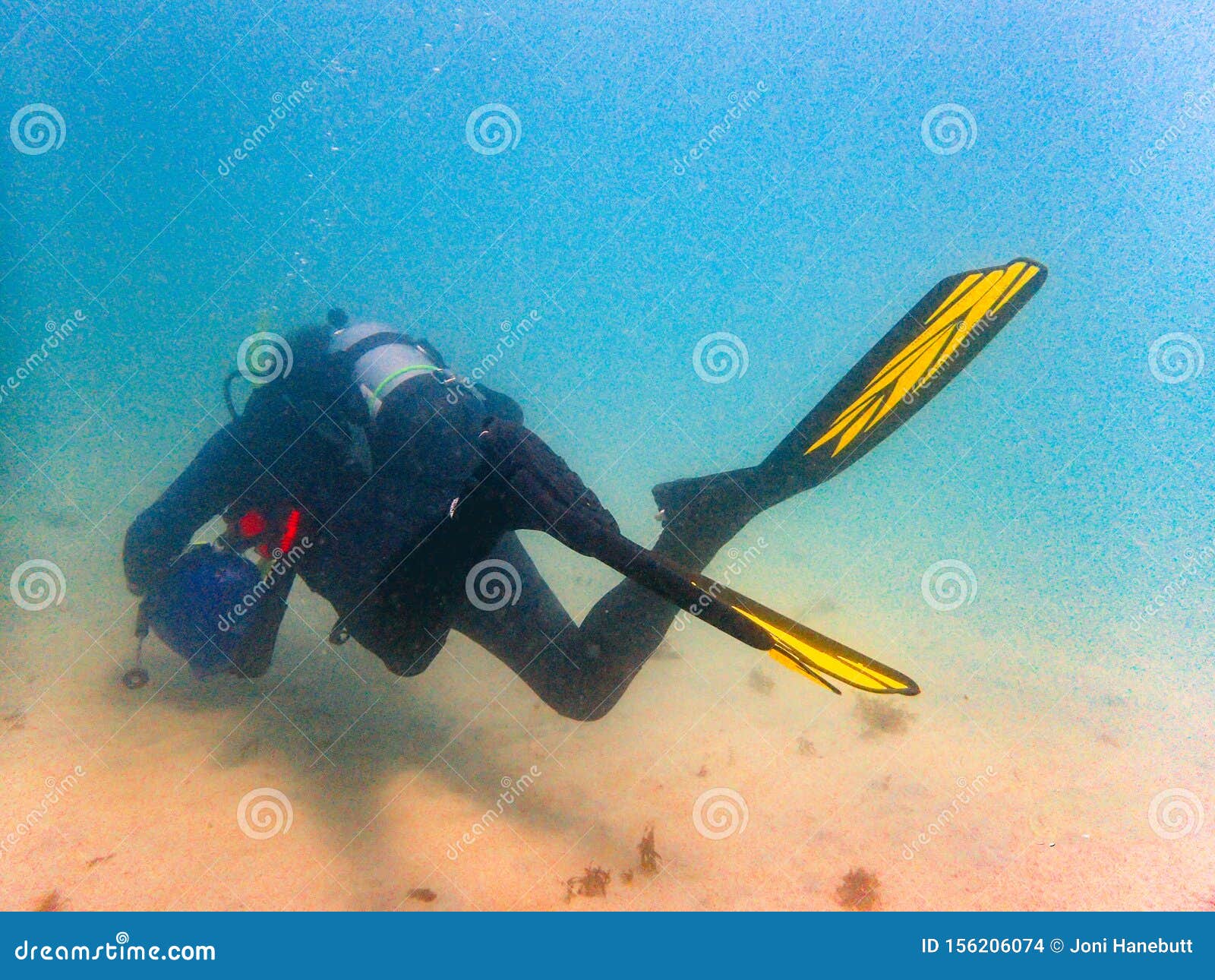 Scuba Diver Swimming through the Ocean Stock Photo - Image of backdrop ...