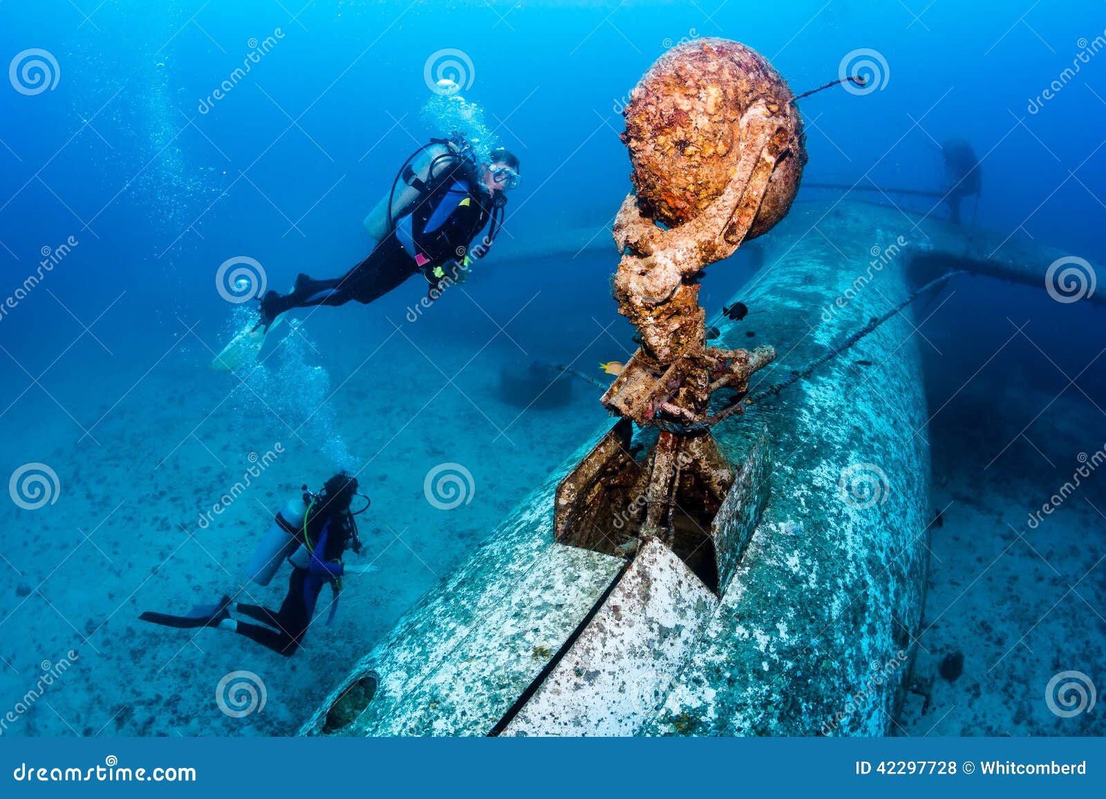 SCUBA Divers Explore the Wreck of an Aircraft Stock Photo - Image of ...