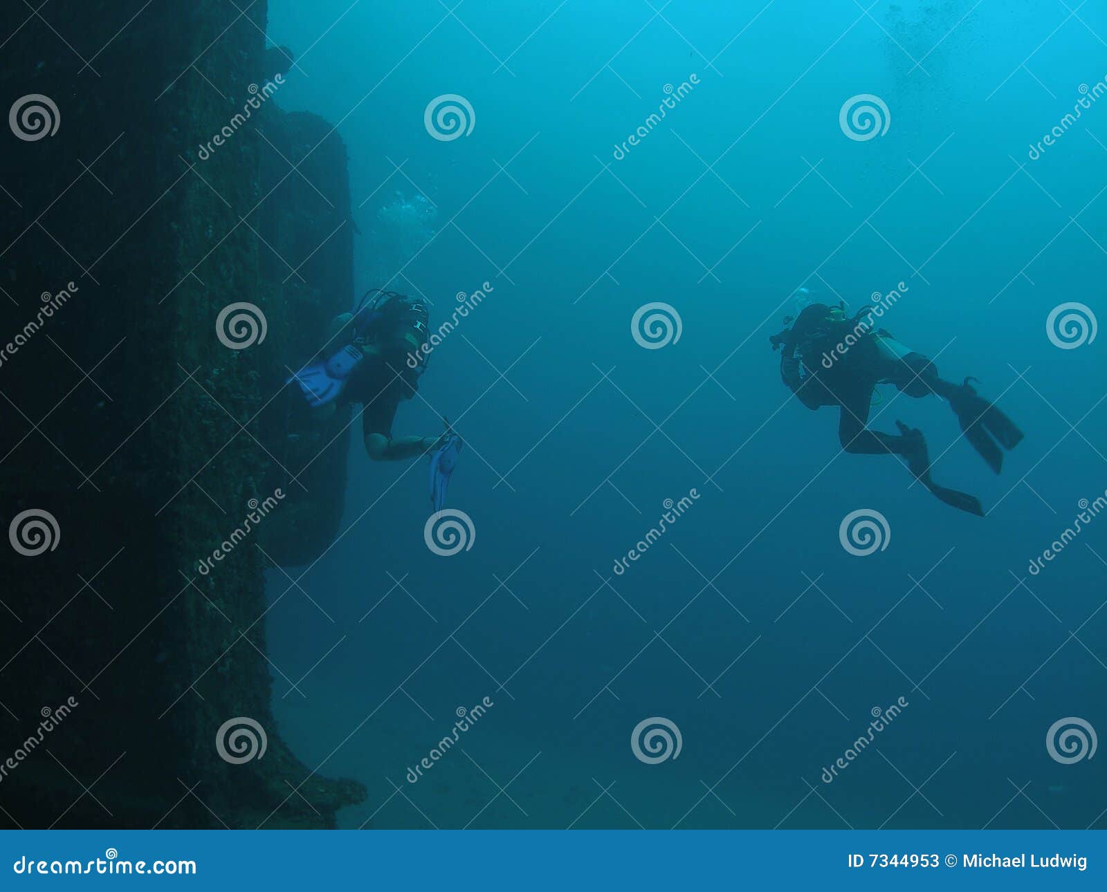 Scuba Divers and a Ship Wreck Stock Image - Image of colourful, color ...