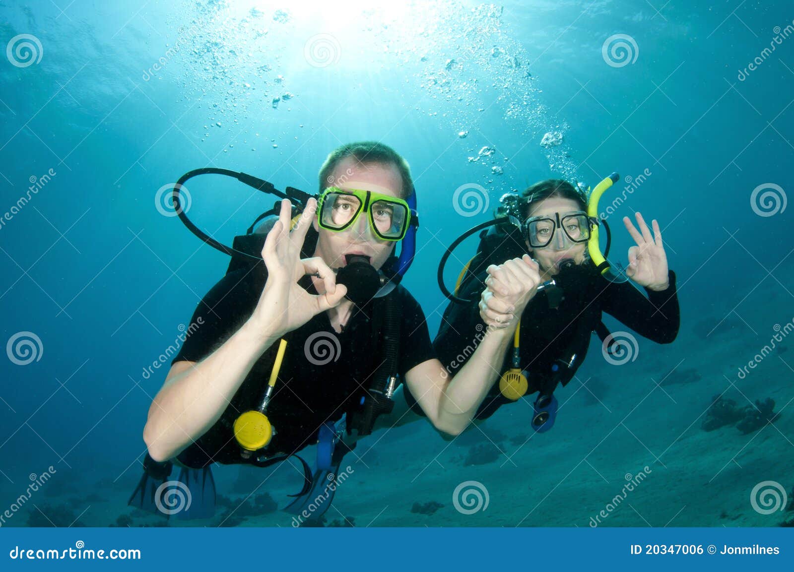 Scuba divers swim together stock photo. Image of fins - 20347006