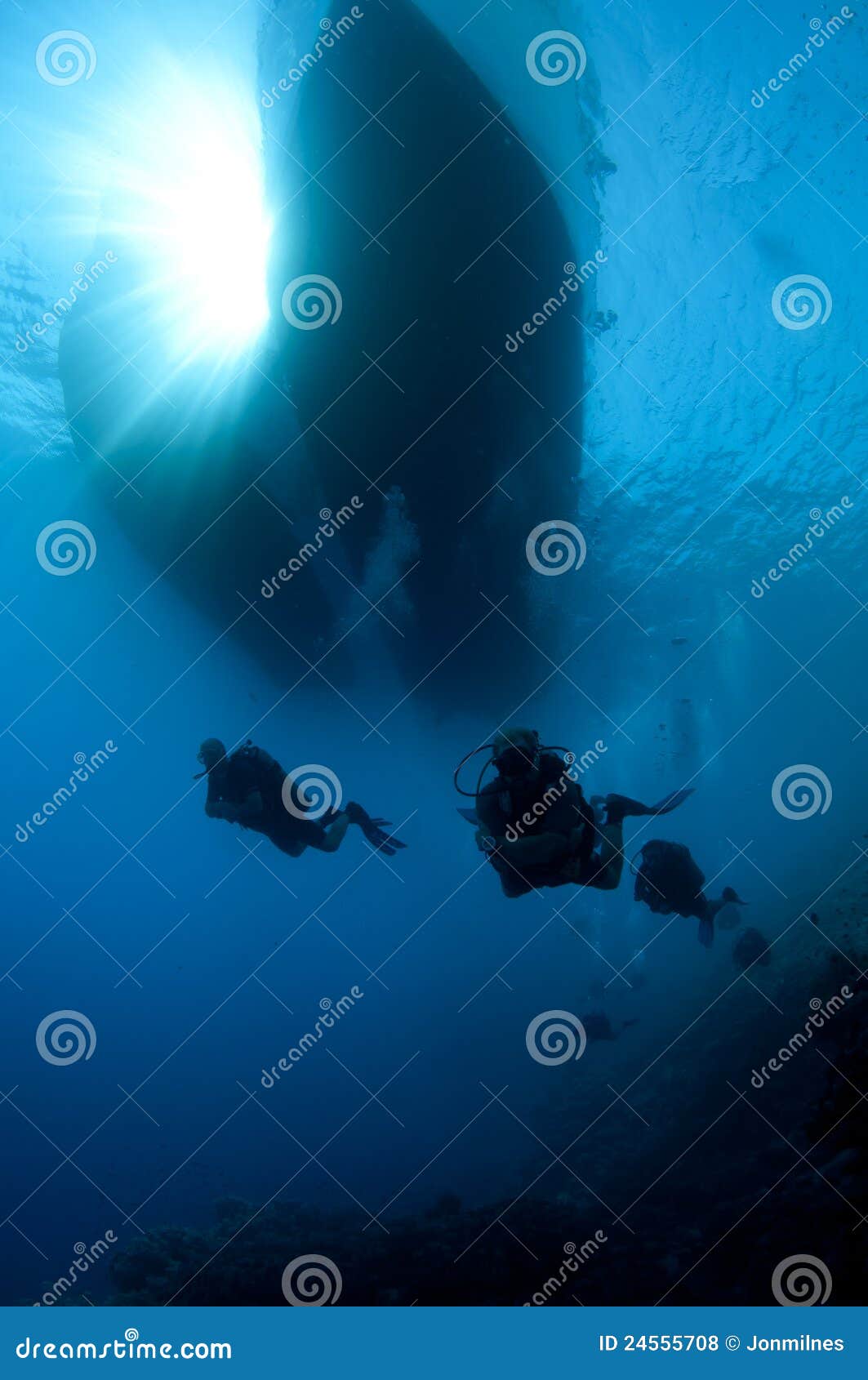 Scuba Divers Under a Boat in Ocean Stock Photo - Image of ocean, dive ...