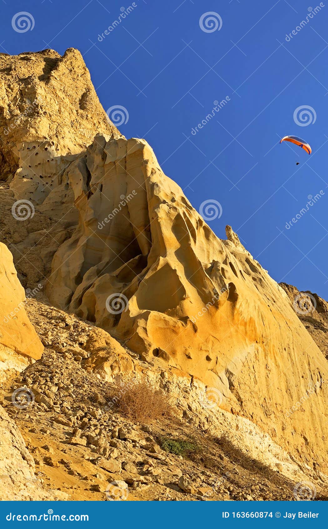 Sculpted Cliffs with Hang Glider Stock Photo - Image of nature, soars ...