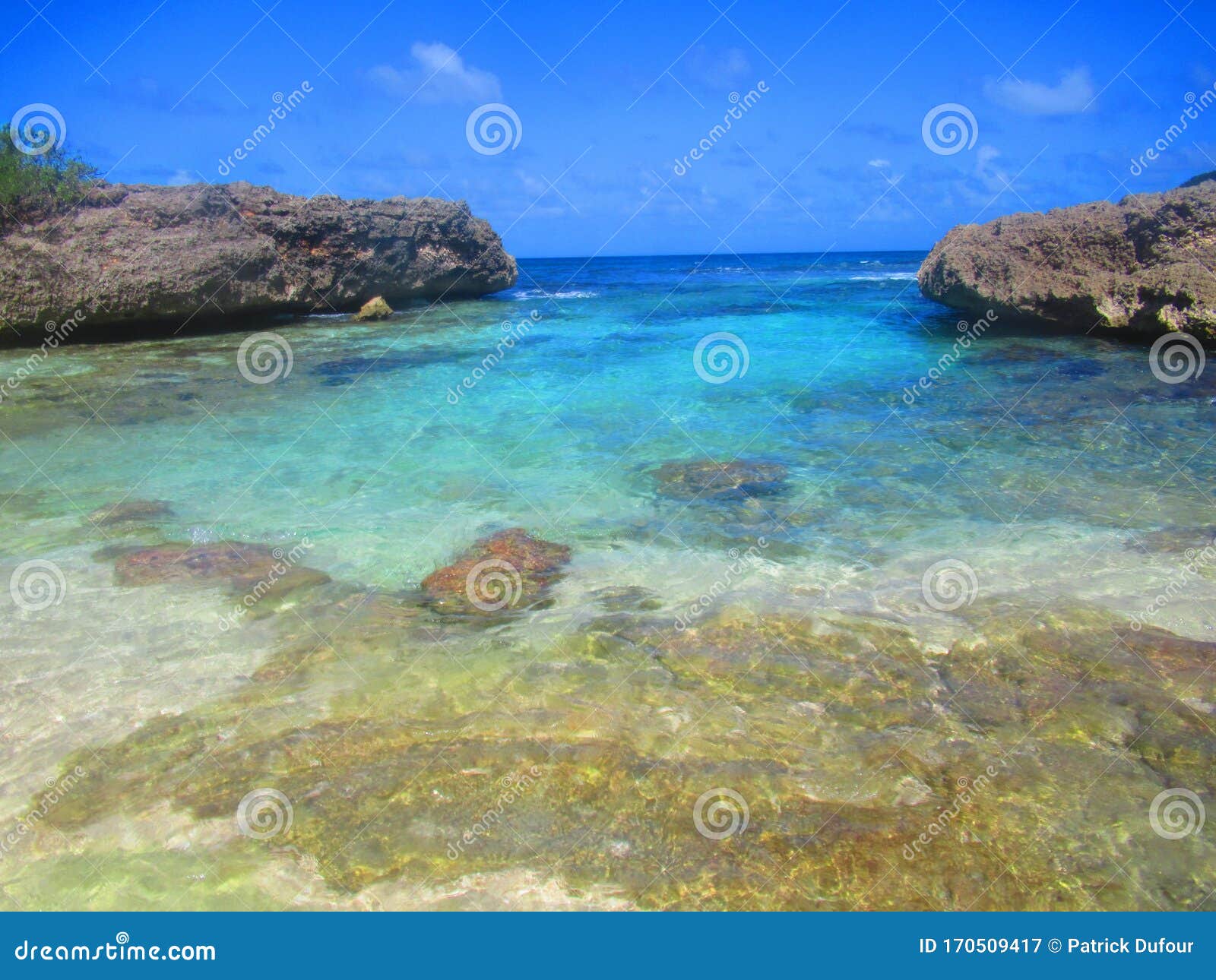 The Sea in a Bay Surrounded by Rocks Stock Image - Image of rock, blue ...