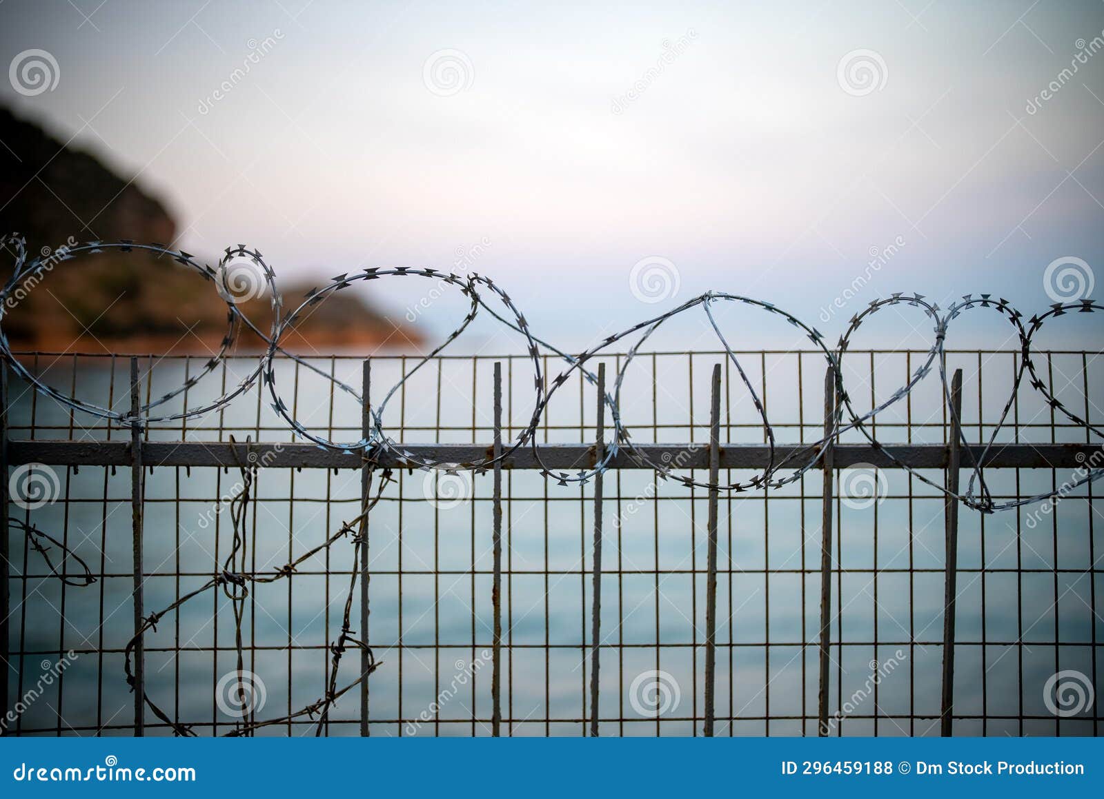 Sea behind barbed wire stock photo. Image of mexico - 296459188