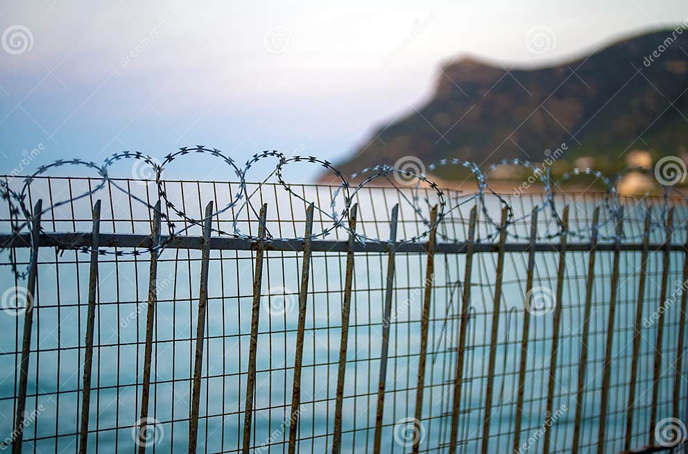 Sea behind barbed wire stock image. Image of nature - 296459189