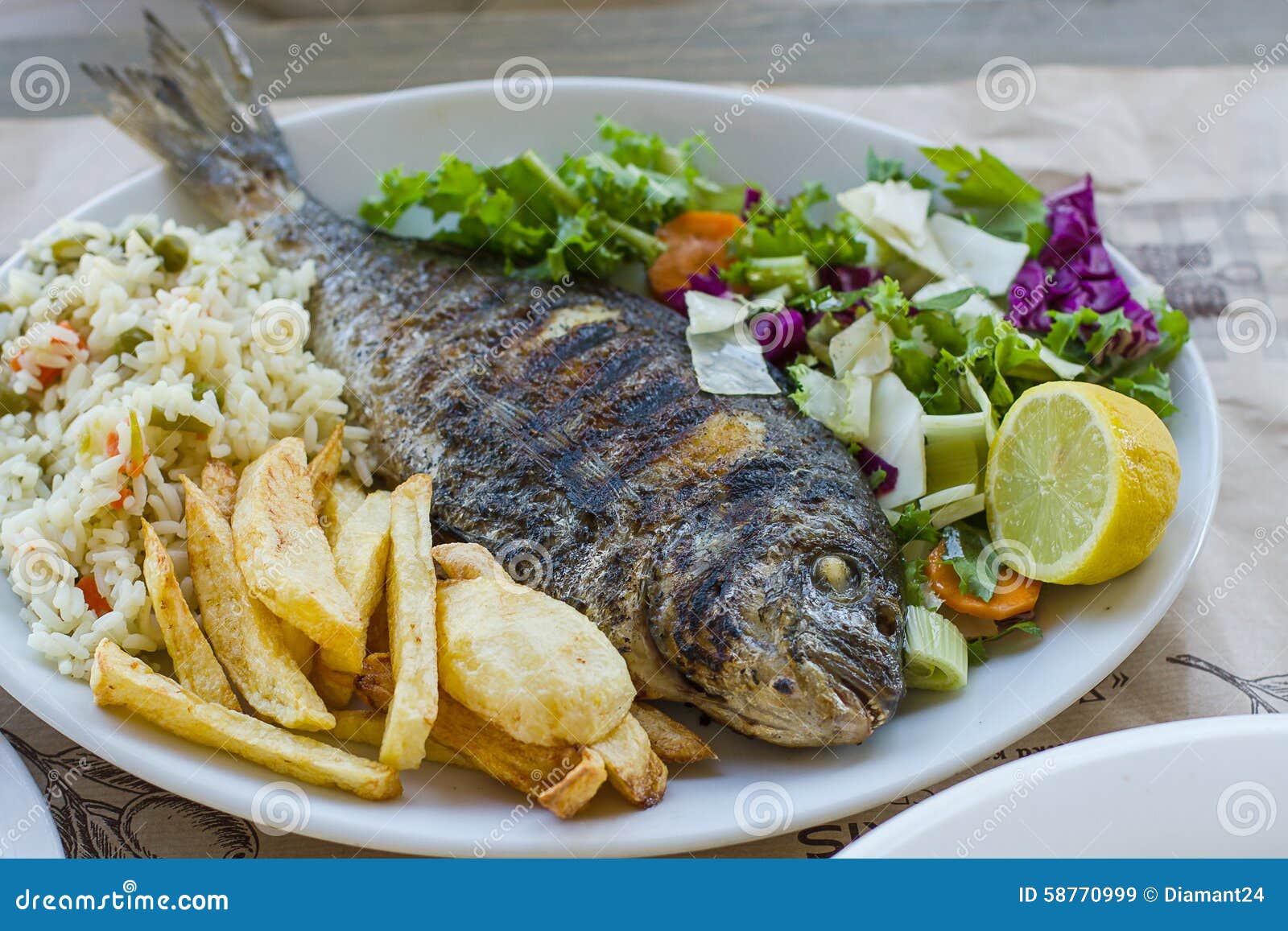 Sea Bream with Potato, Rice and Salad Stock Image - Image of bream ...