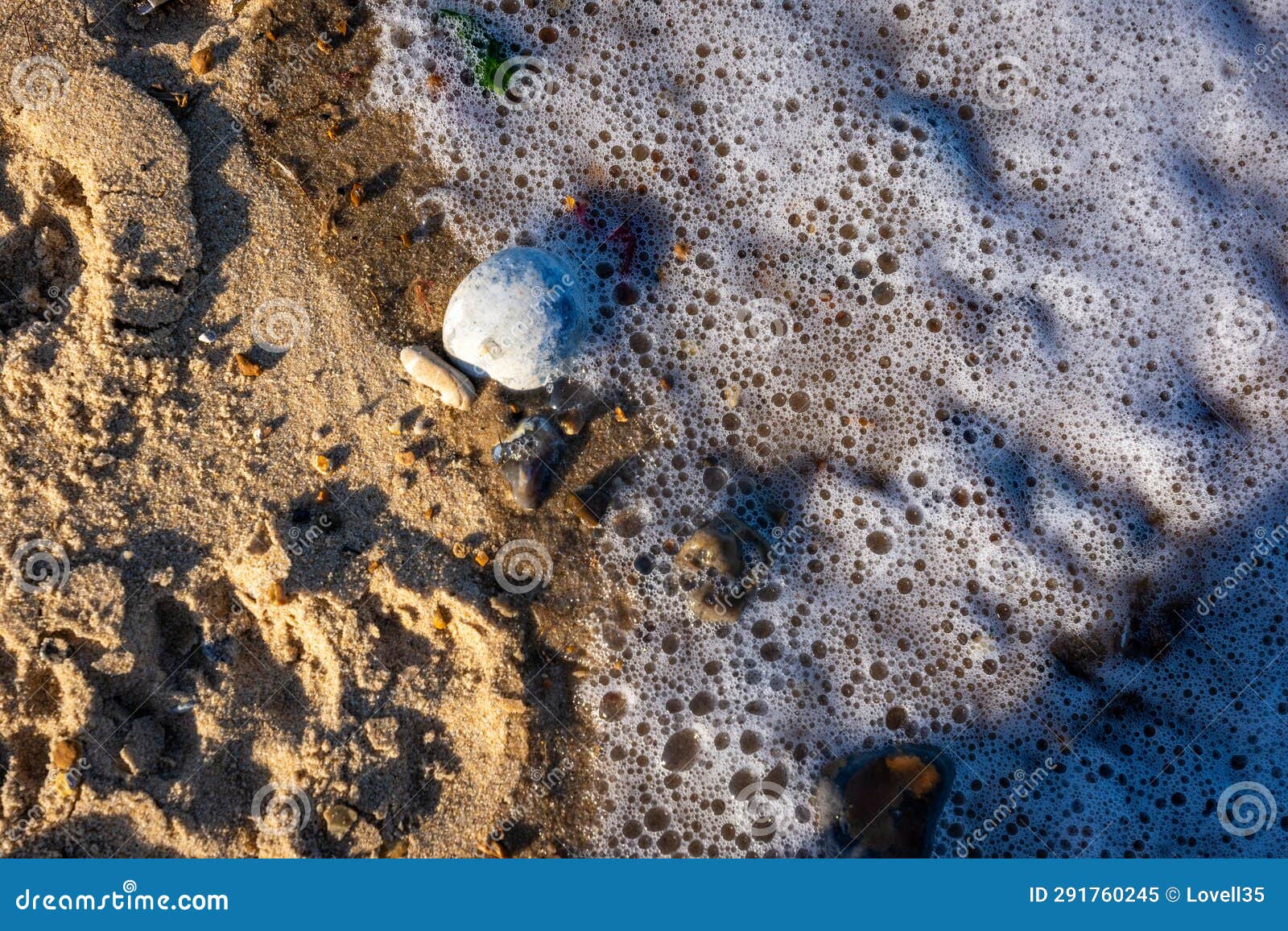 Sea Foam on Beach with Large Stone Stock Image - Image of sand, geology ...