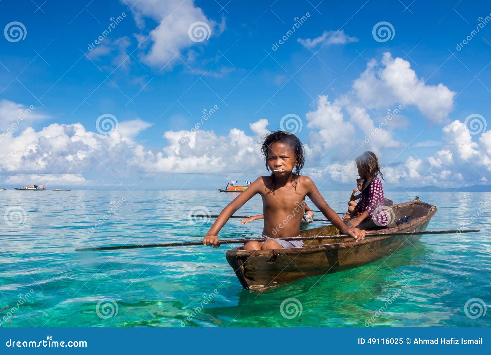 Sea Gypsy Kids On Their Sampan With Their House On Stilts In The ...