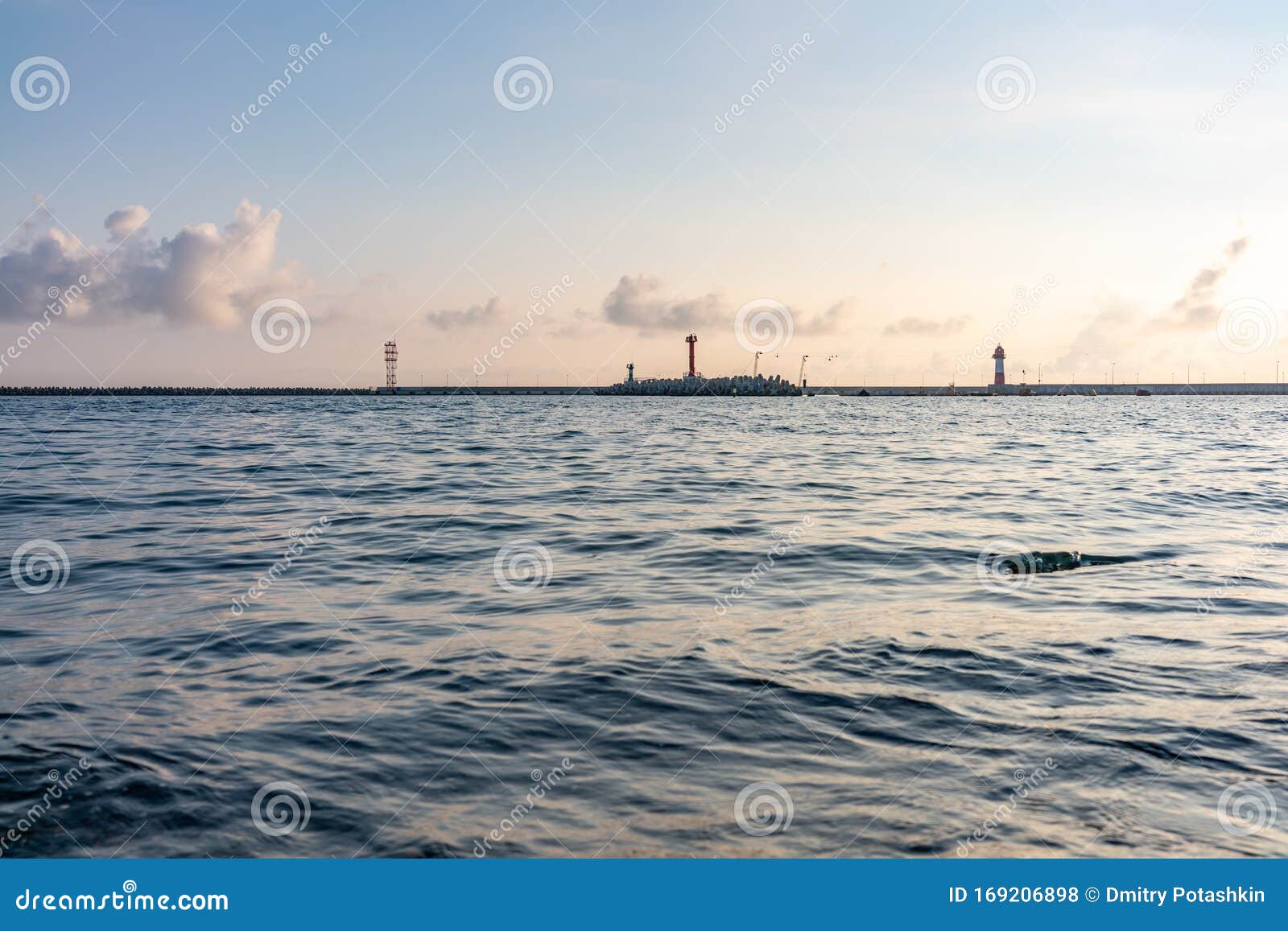 Sea Harbor with Breakwater and Lighthouse at Sunset Stock Photo - Image ...