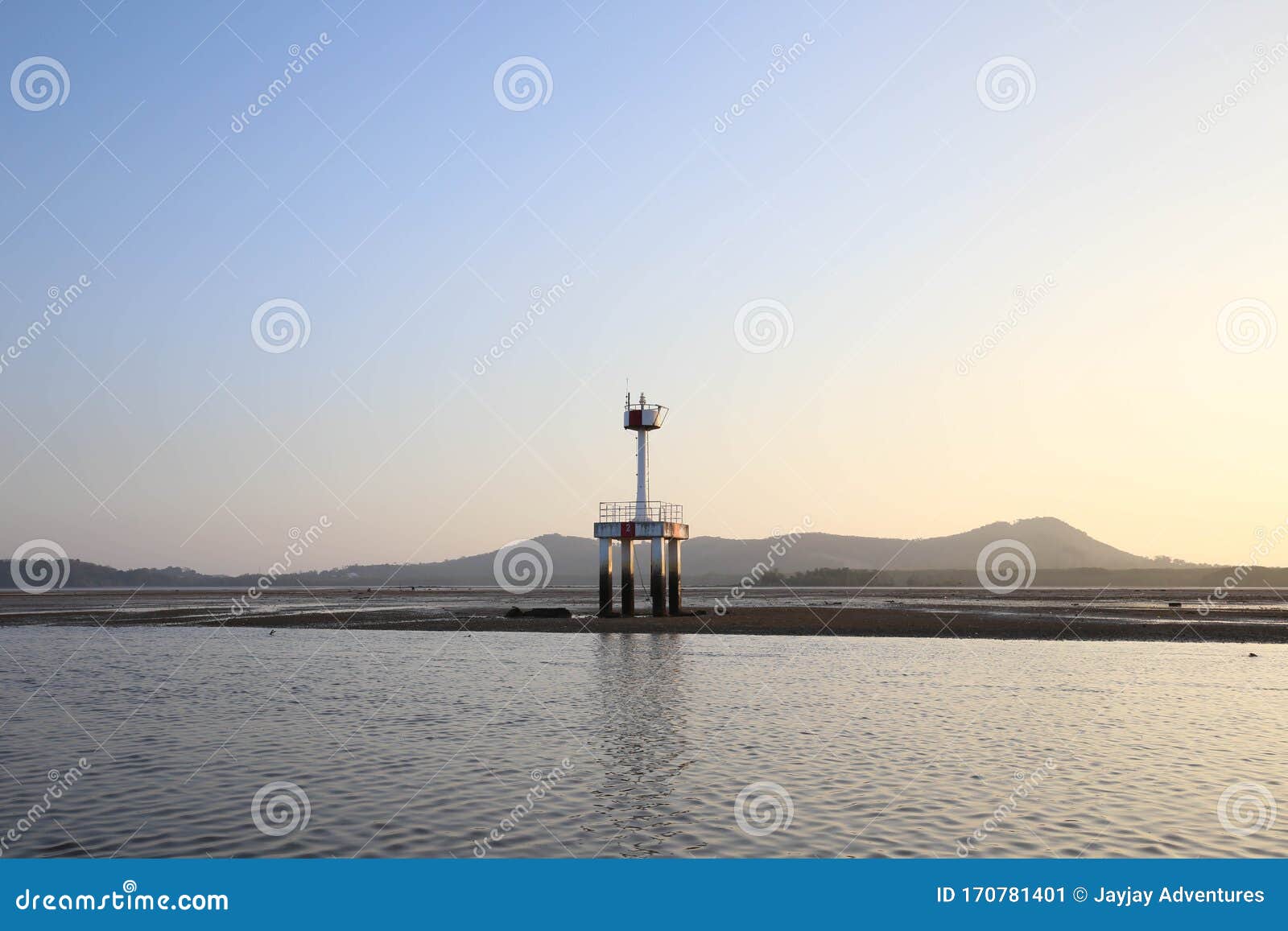 Sea at Low Tide with Lighthouse in Background Stock Image - Image of ...