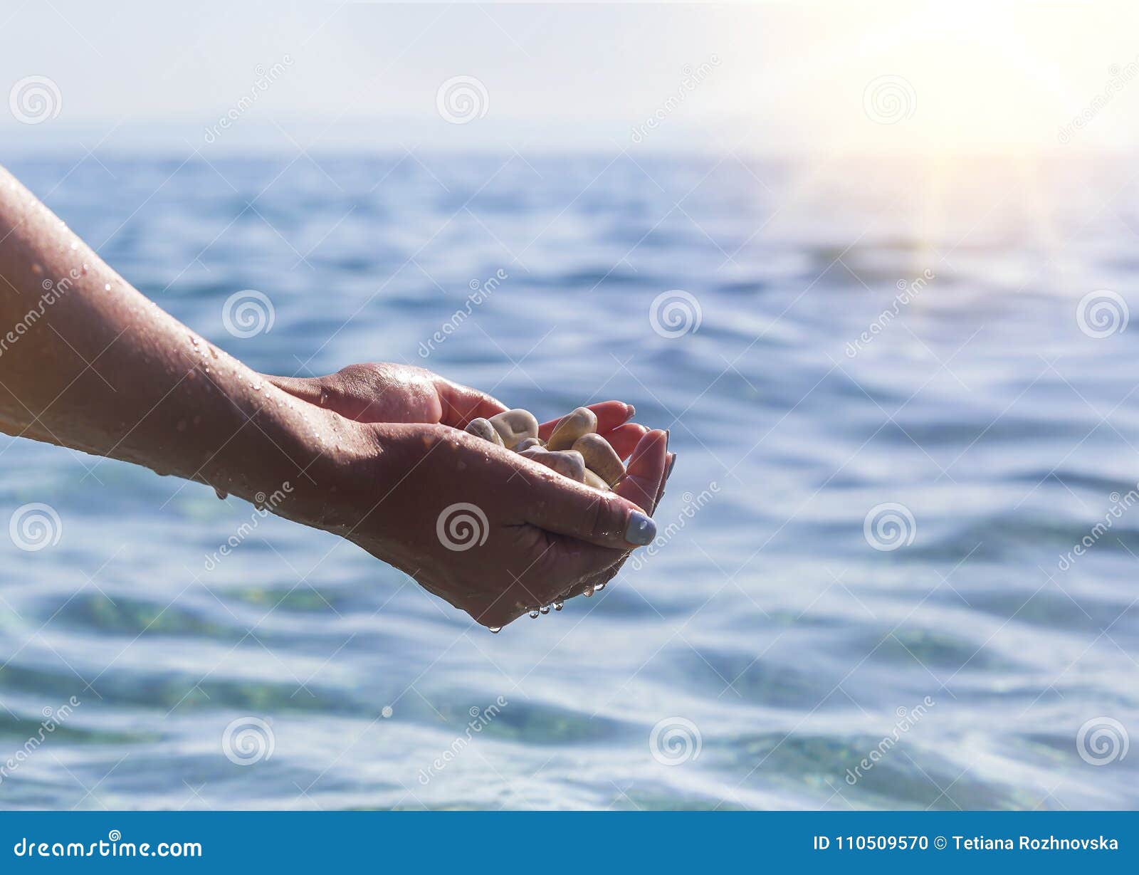 Sea pebbles in the hand. stock photo. Image of pebbles - 110509570