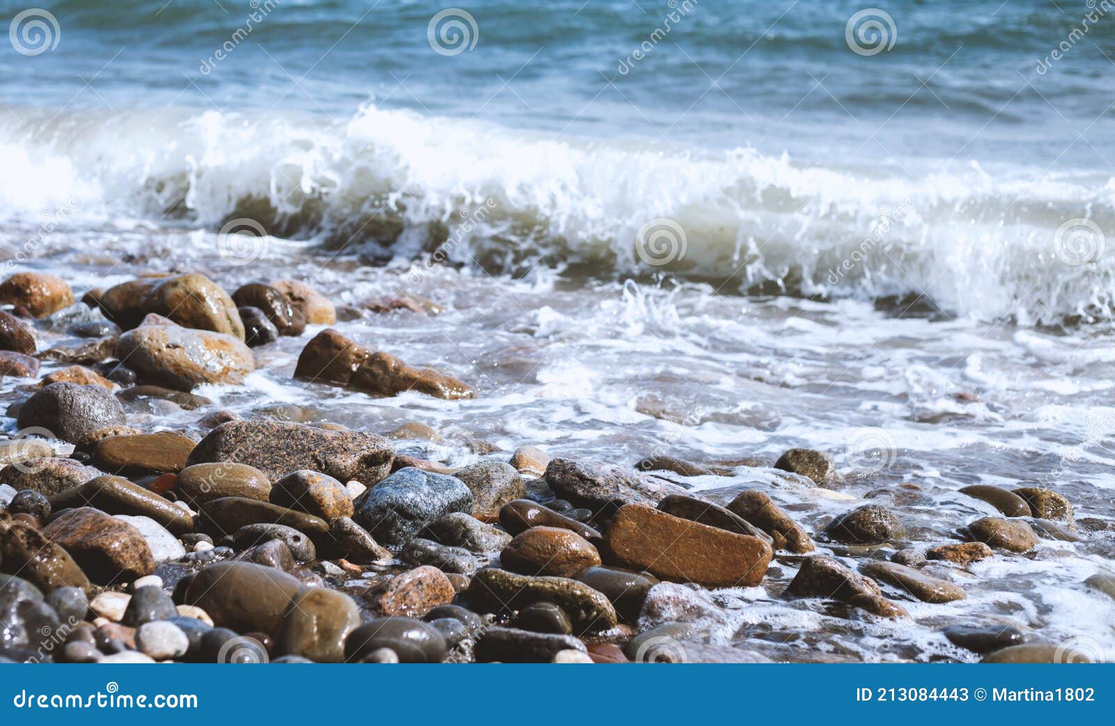 Sea pebbles and wave stock image. Image of natural, sand - 213084443