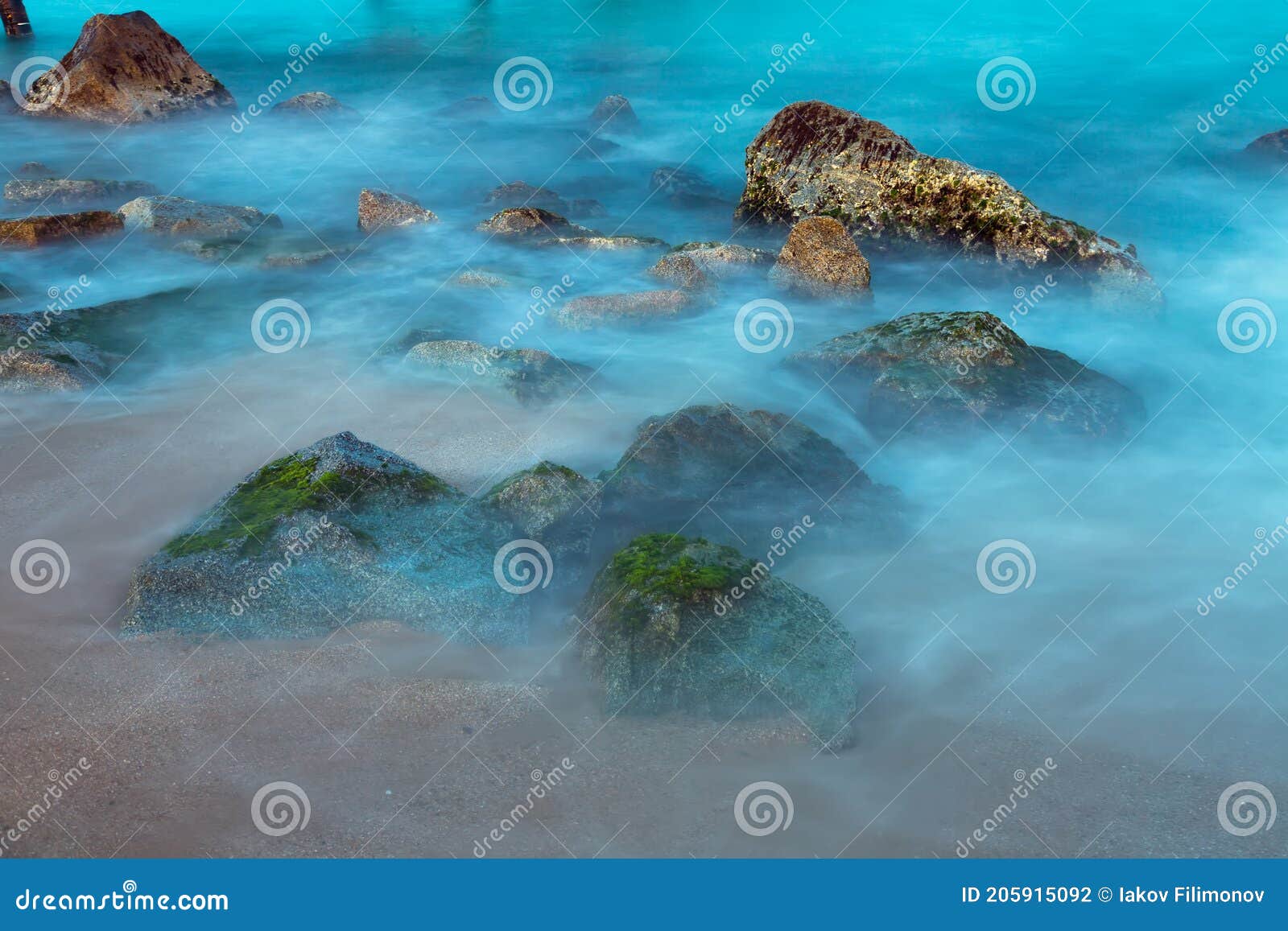 Sea rocks in mist at dusk stock photo. Image of dusk - 205915092