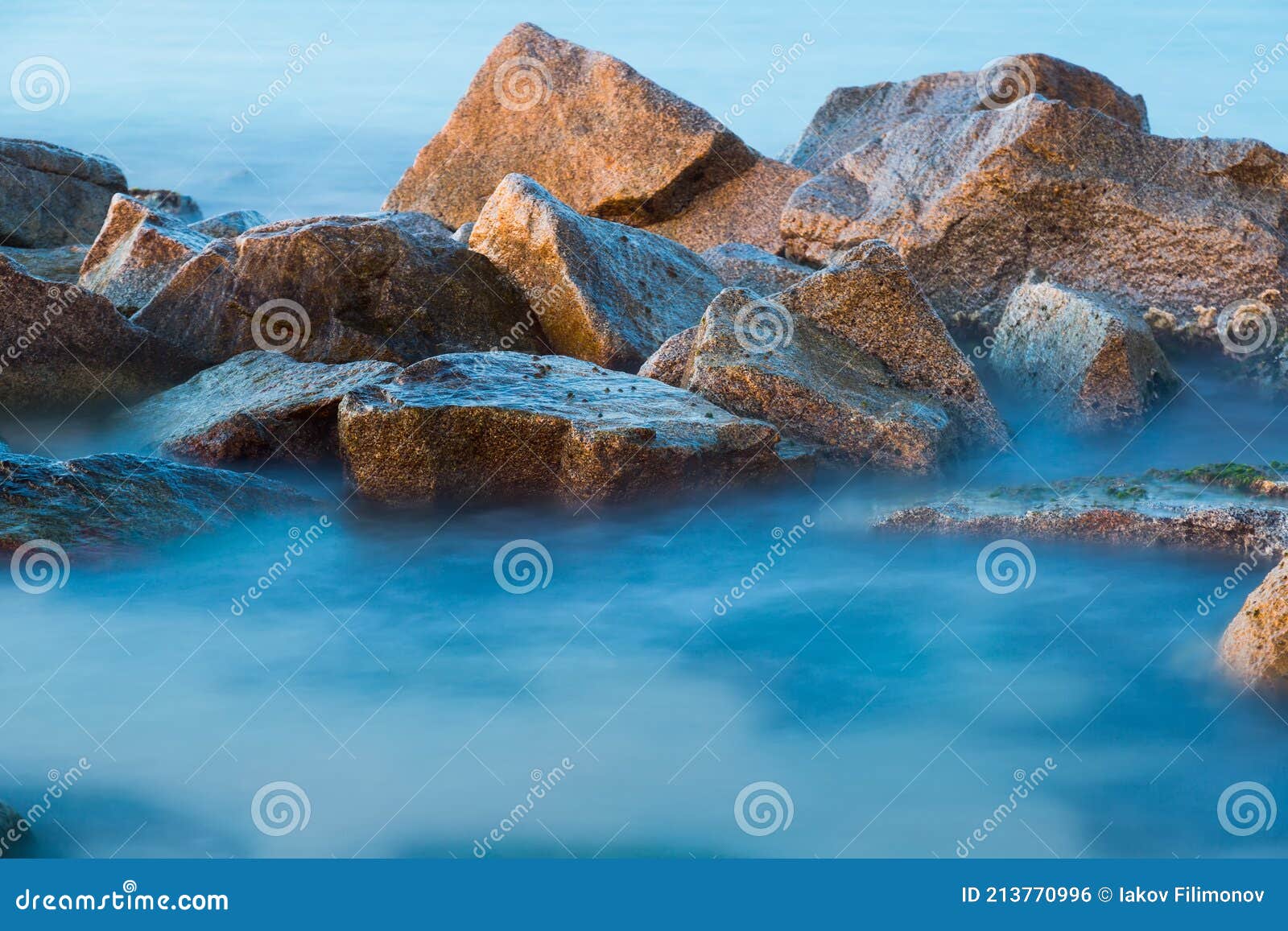 Sea rocks in mist at dusk stock photo. Image of mystical - 213770996