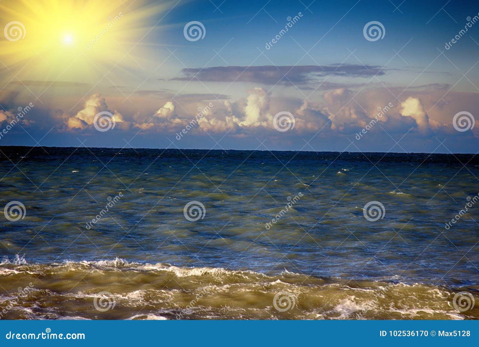 Sea Rolling and Receding Water in Rays of Setting Sun. Stock Photo ...