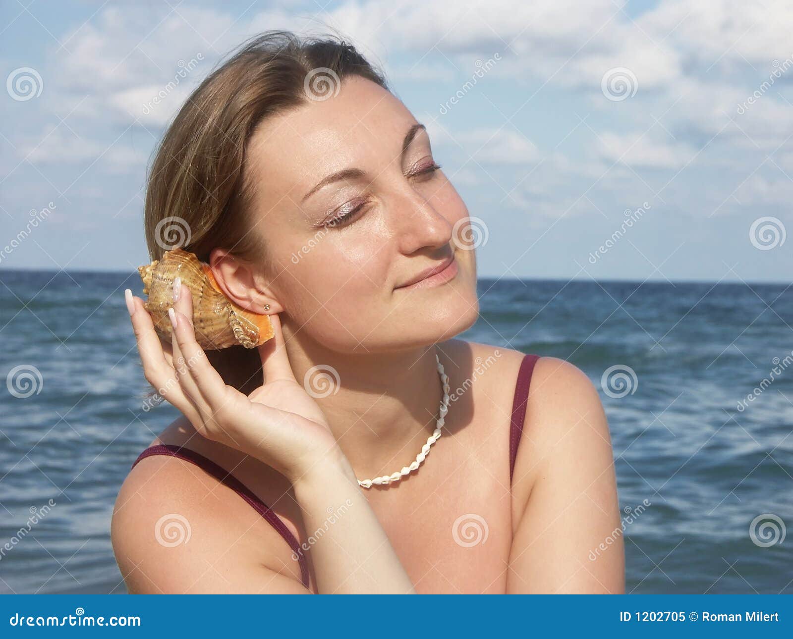 Sea shell murmuring stock image. Image of people, bikini - 1202705