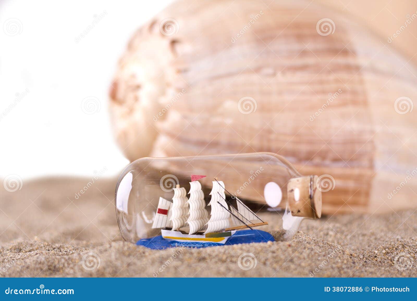 Sea Shell and Ship in the Bottle on the Beach Stock Photo - Image of ...