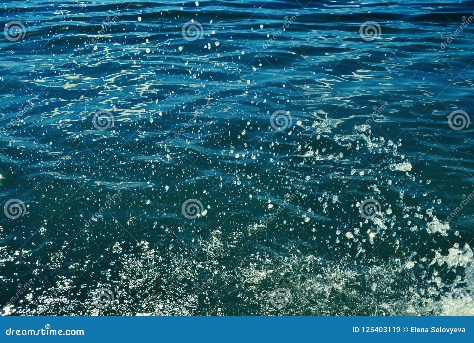 Sea Spray Flying Off from the Side in the Sun Against the Background of ...