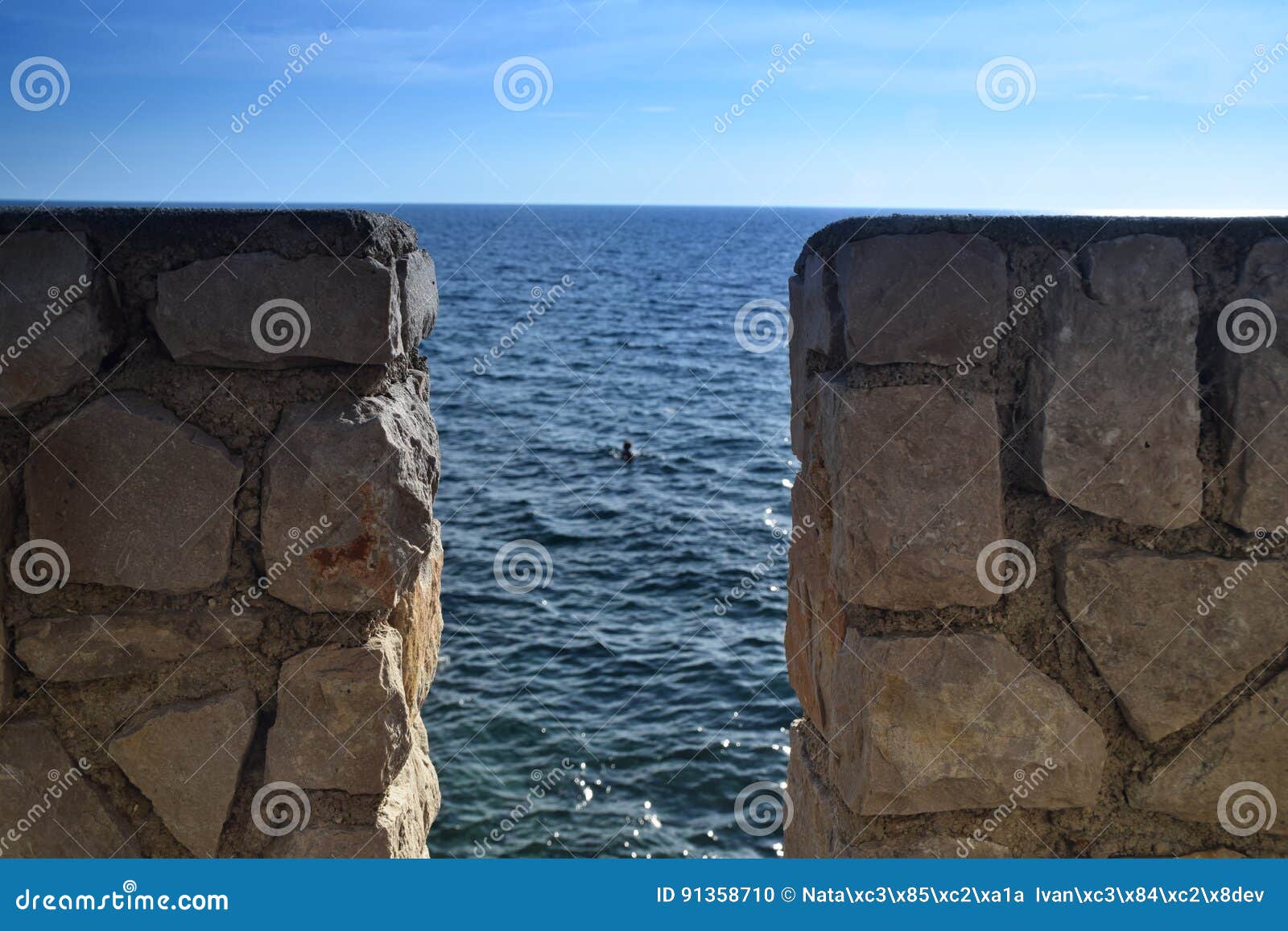 Sea and Swimmers through a Stone Wall Stock Photo - Image of nature ...