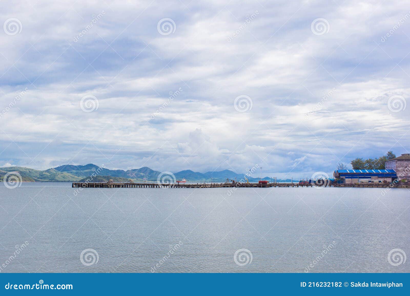 The Sea View and Port with Sky is Full of Clouds. There is Mountain on ...
