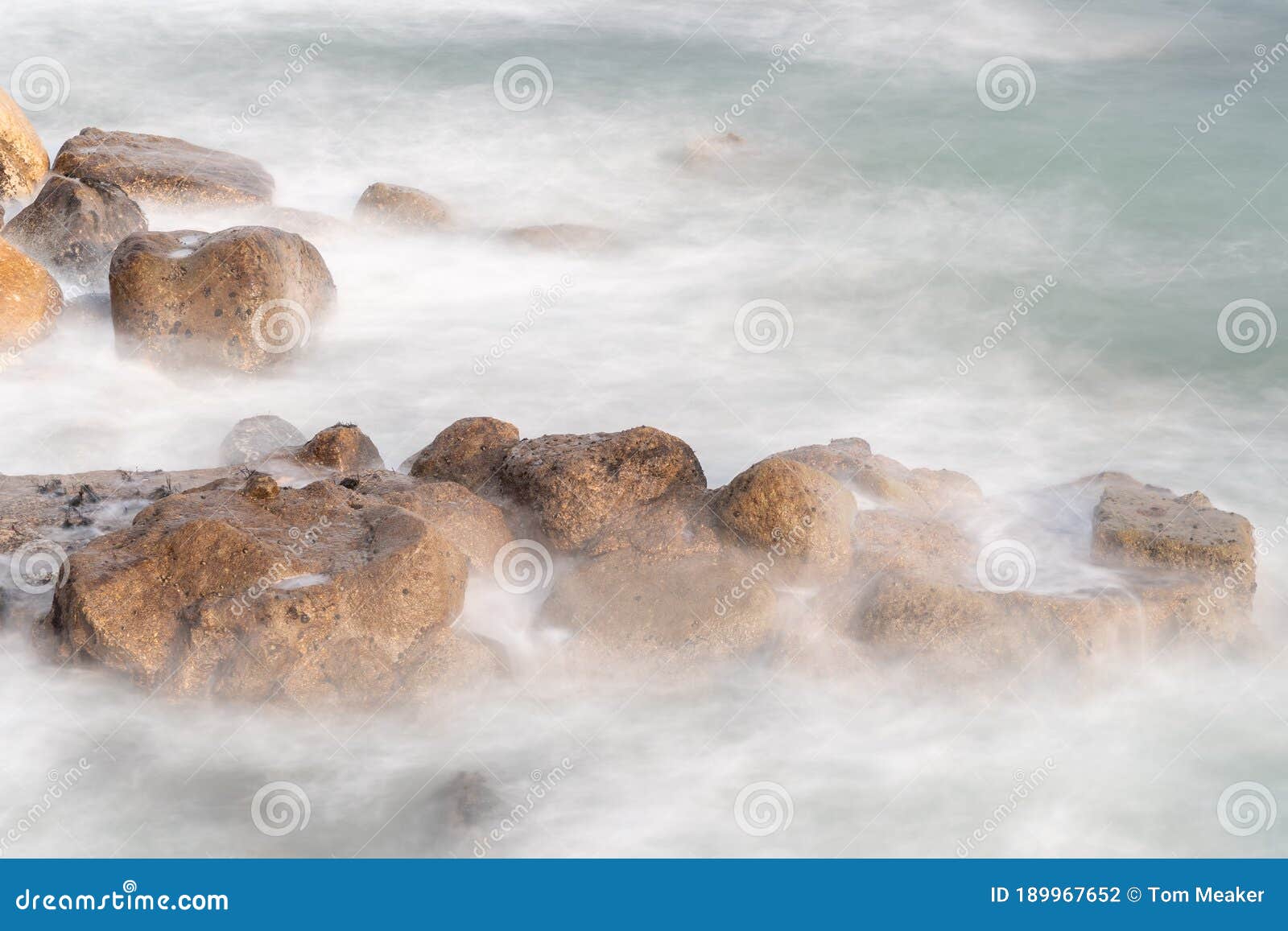 Sea washing over rocks stock photo. Image of nature - 189967652