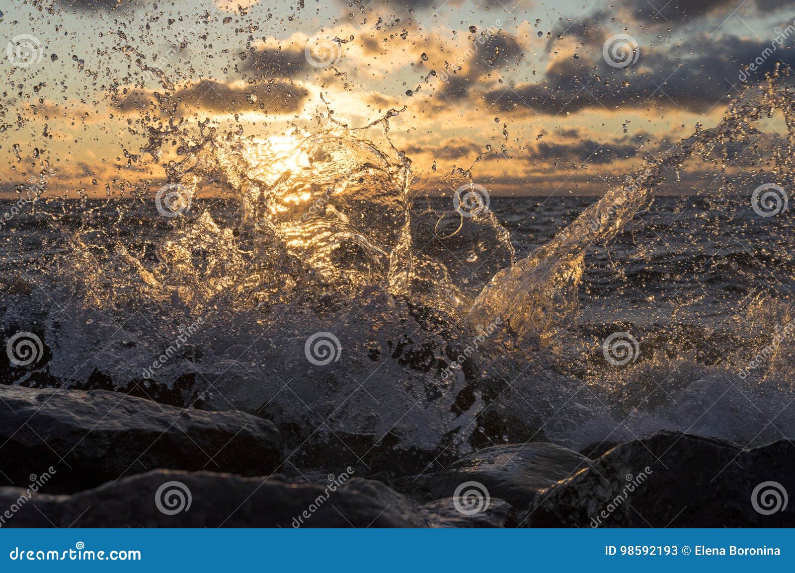 Sea Wave Breaks about Stones, Splashes at Sunset Stock Image - Image of ...