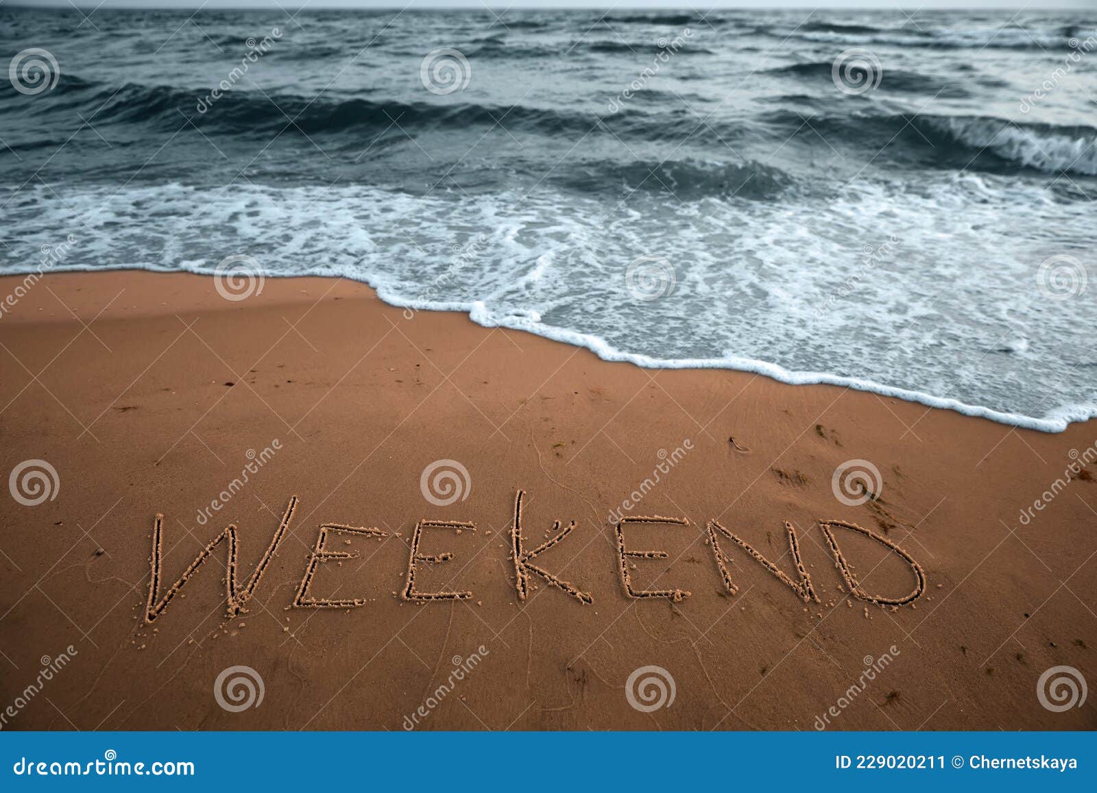 Sea Wave Rolling Onto Sandy Beach with Written Word Weekend Stock Image ...