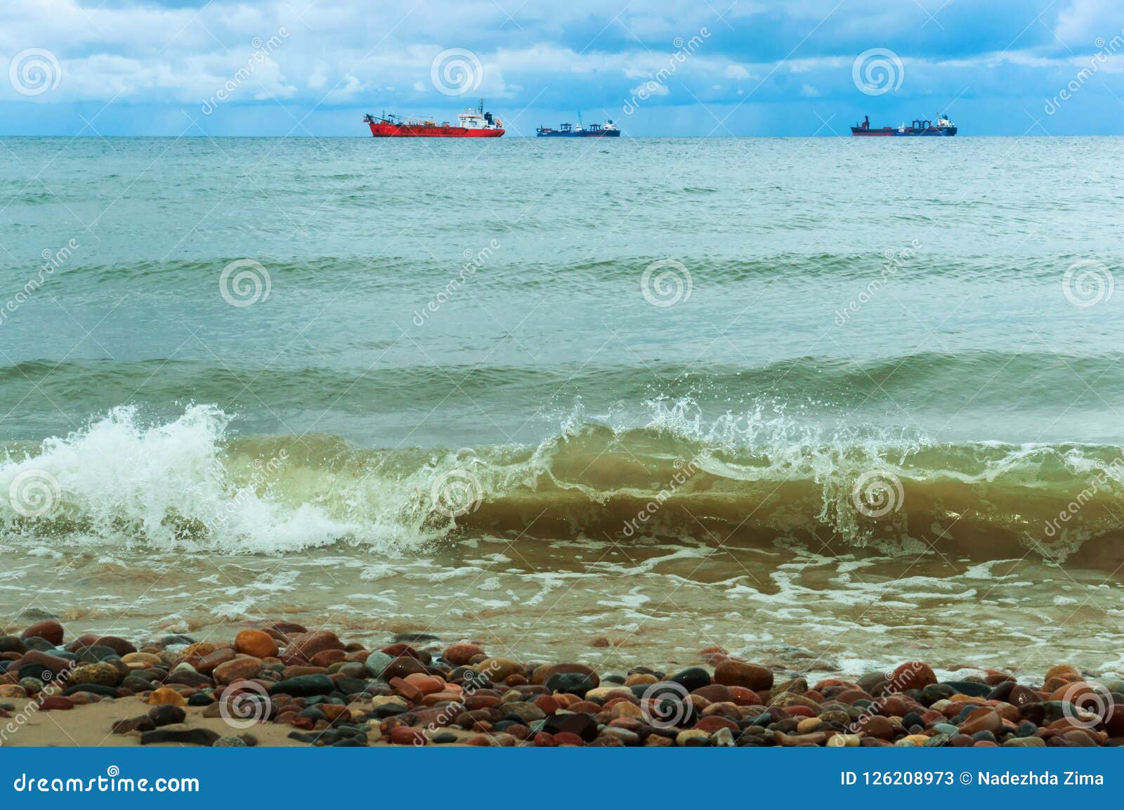 A Sea Wave Washed Over the Shore, Three Ships on the Horizon Stock ...