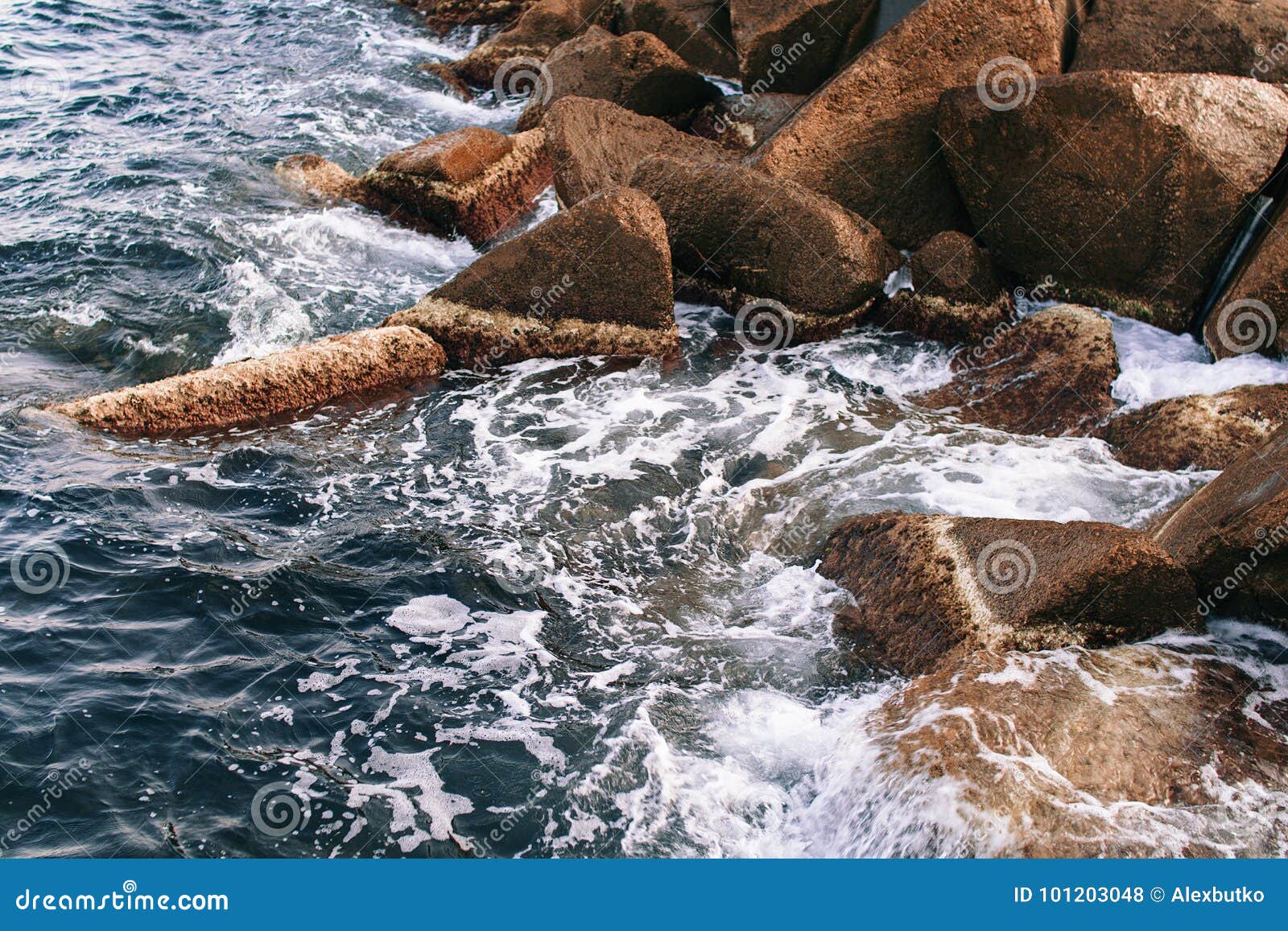 Sea waves break on stones stock photo. Image of wave - 101203048