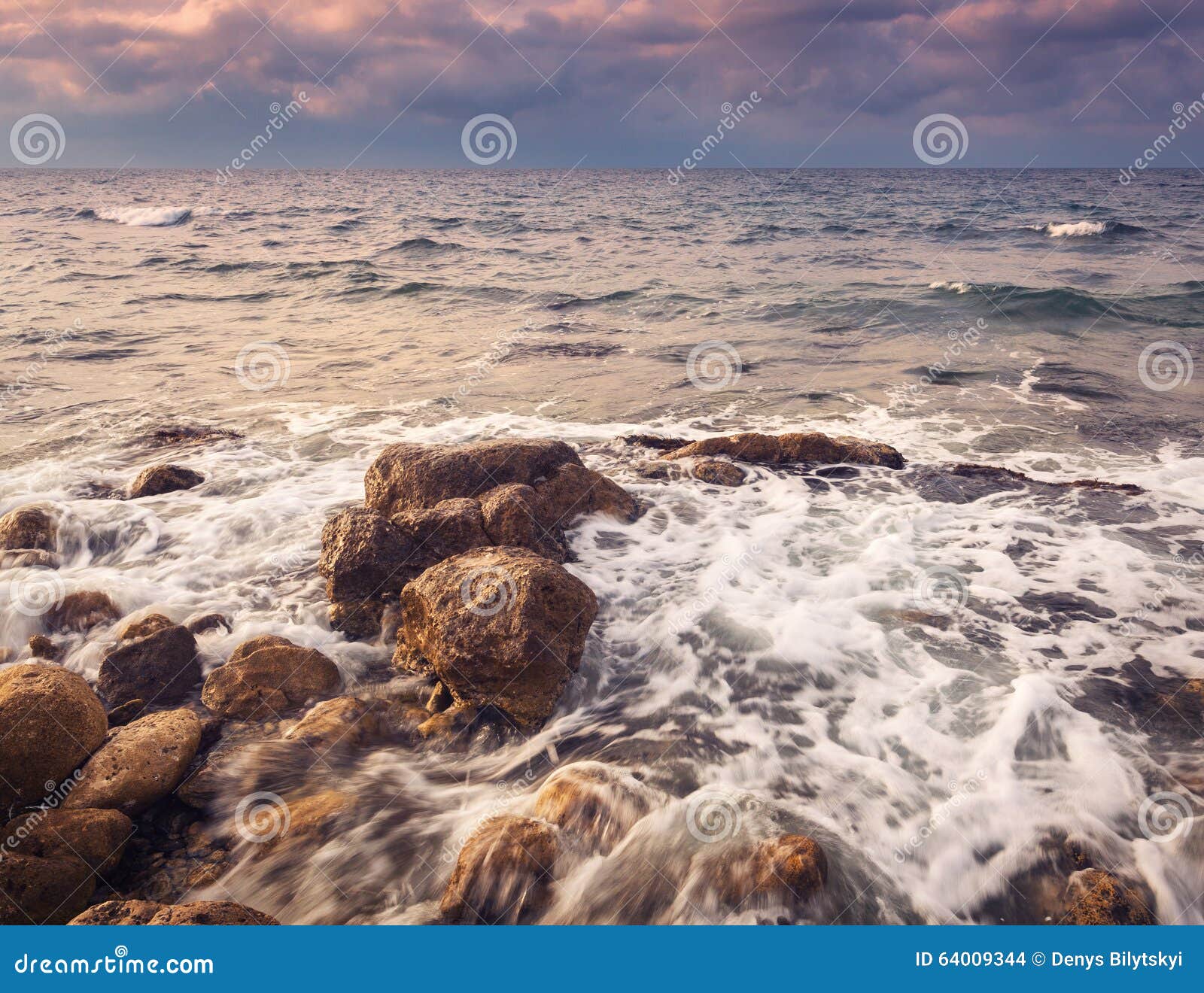 Sea Waves with Rocks on the Beach at Sunset Stock Photo - Image of ...