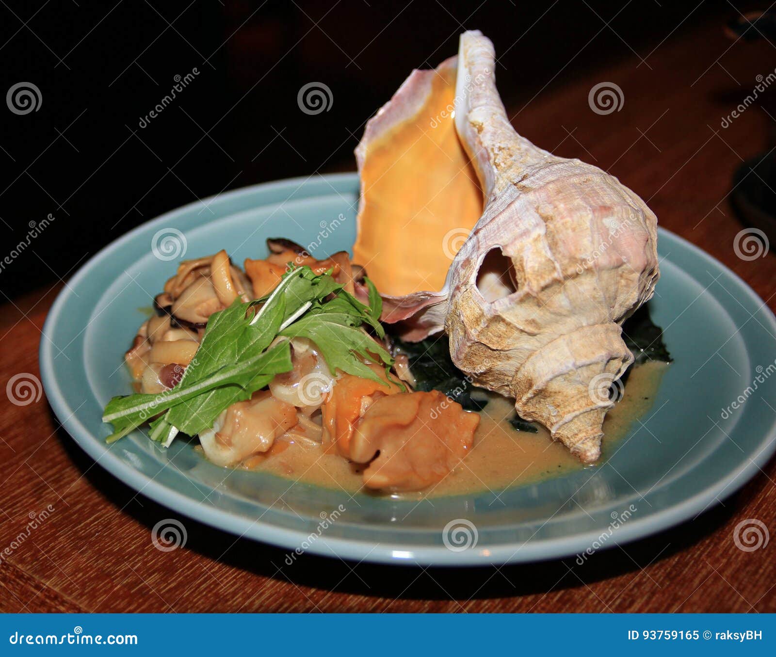 Seafood Dish with Conch Shell in a Plate, Side View Stock Image - Image ...
