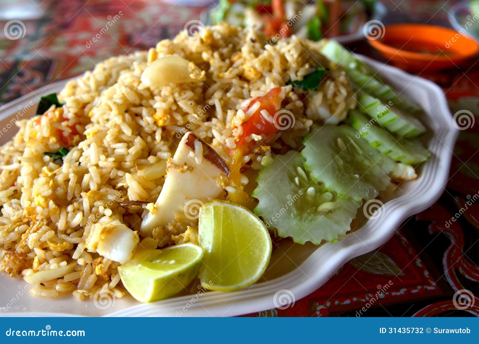 Seafood Fried Rice with Cucumber and Lemon Stock Photo - Image of onion ...