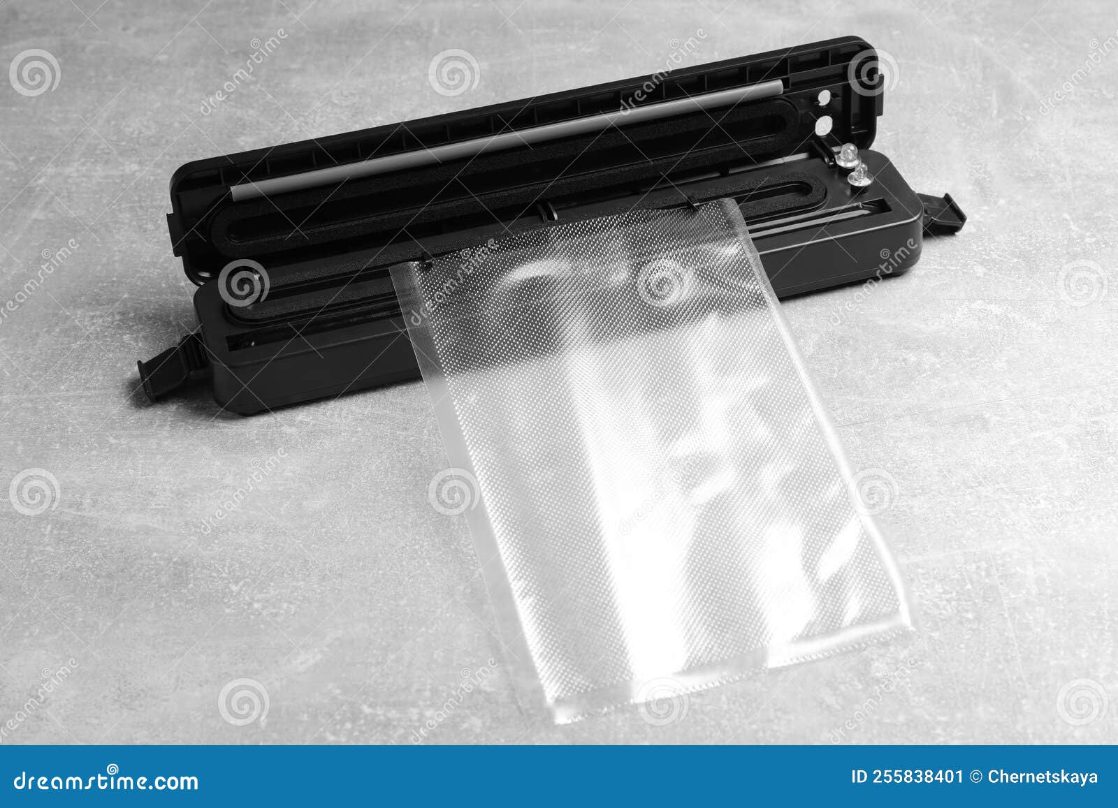Sealer for Vacuum Packing with Plastic Bag on Light Grey Table Stock ...