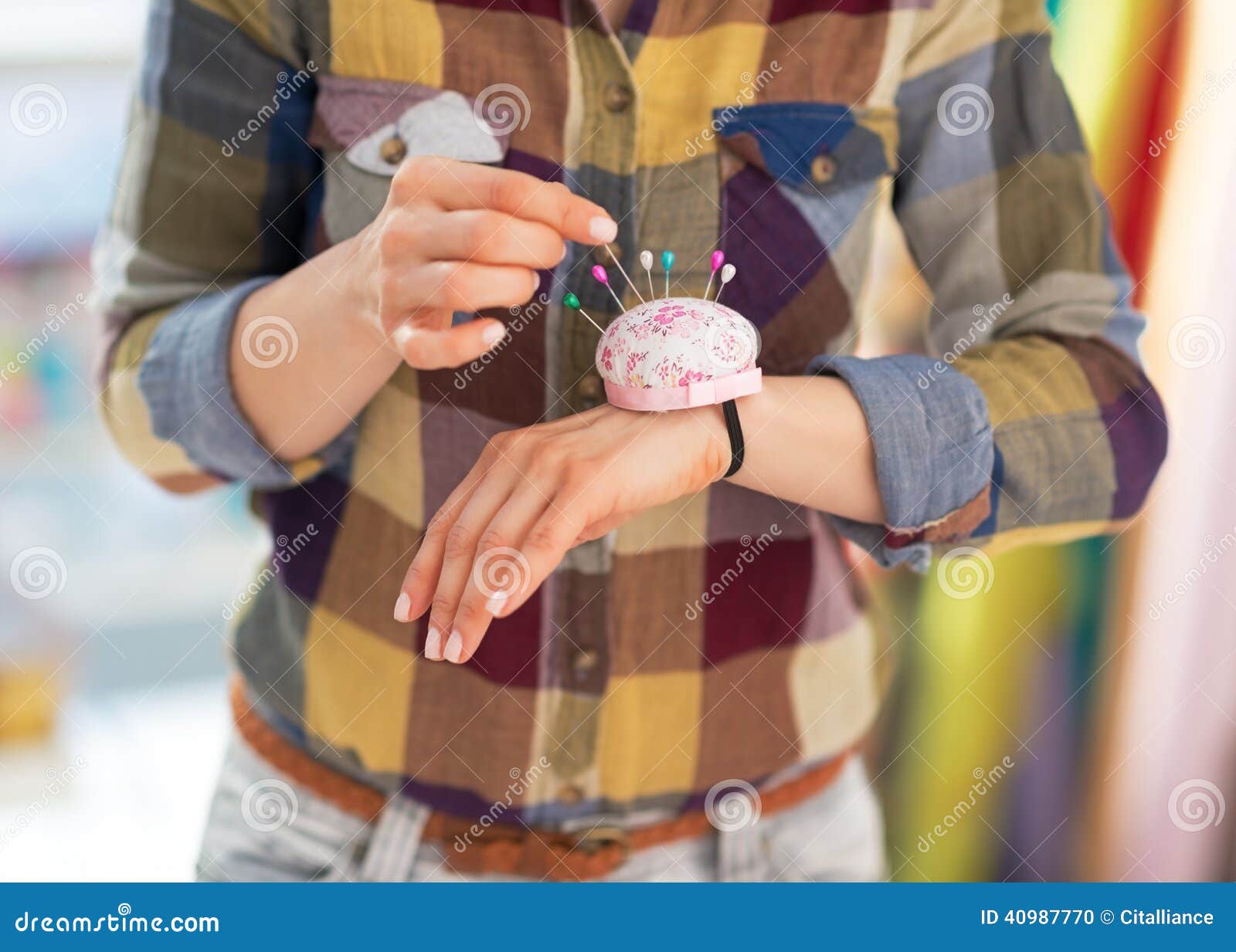 Seamstress Putting Needle into Pincushion Stock Photo - Image of design ...