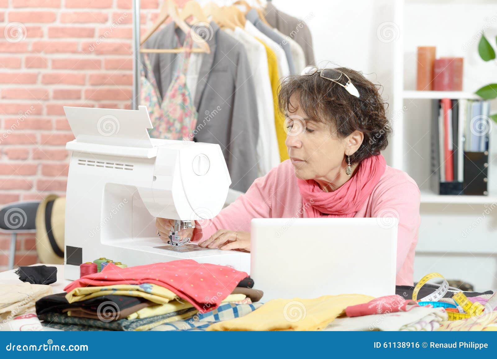 Seamstress Sitting at a Sewing Machine Stock Photo - Image of ...