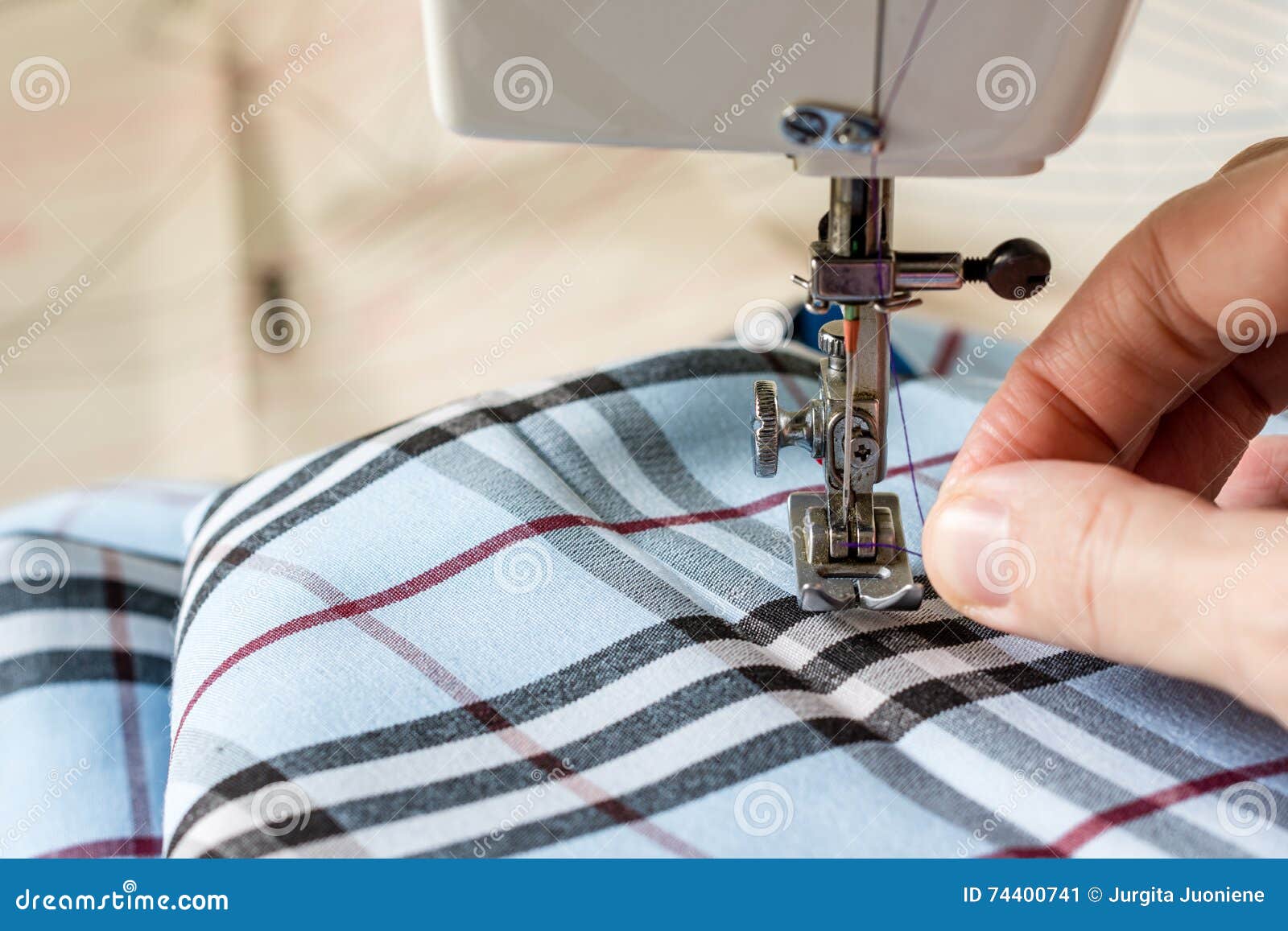 Seamstress is Threading a Needle and Prepares for Sewing with Machine ...
