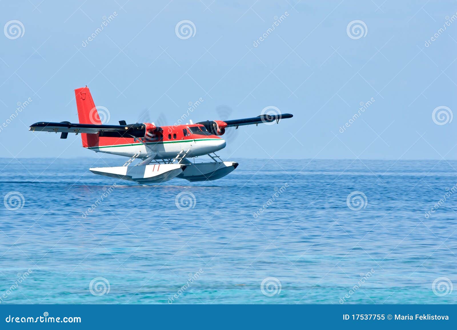 Seaplane Landing In The Ocean Lagoon. Seaplane Takeoff From The Stock ...